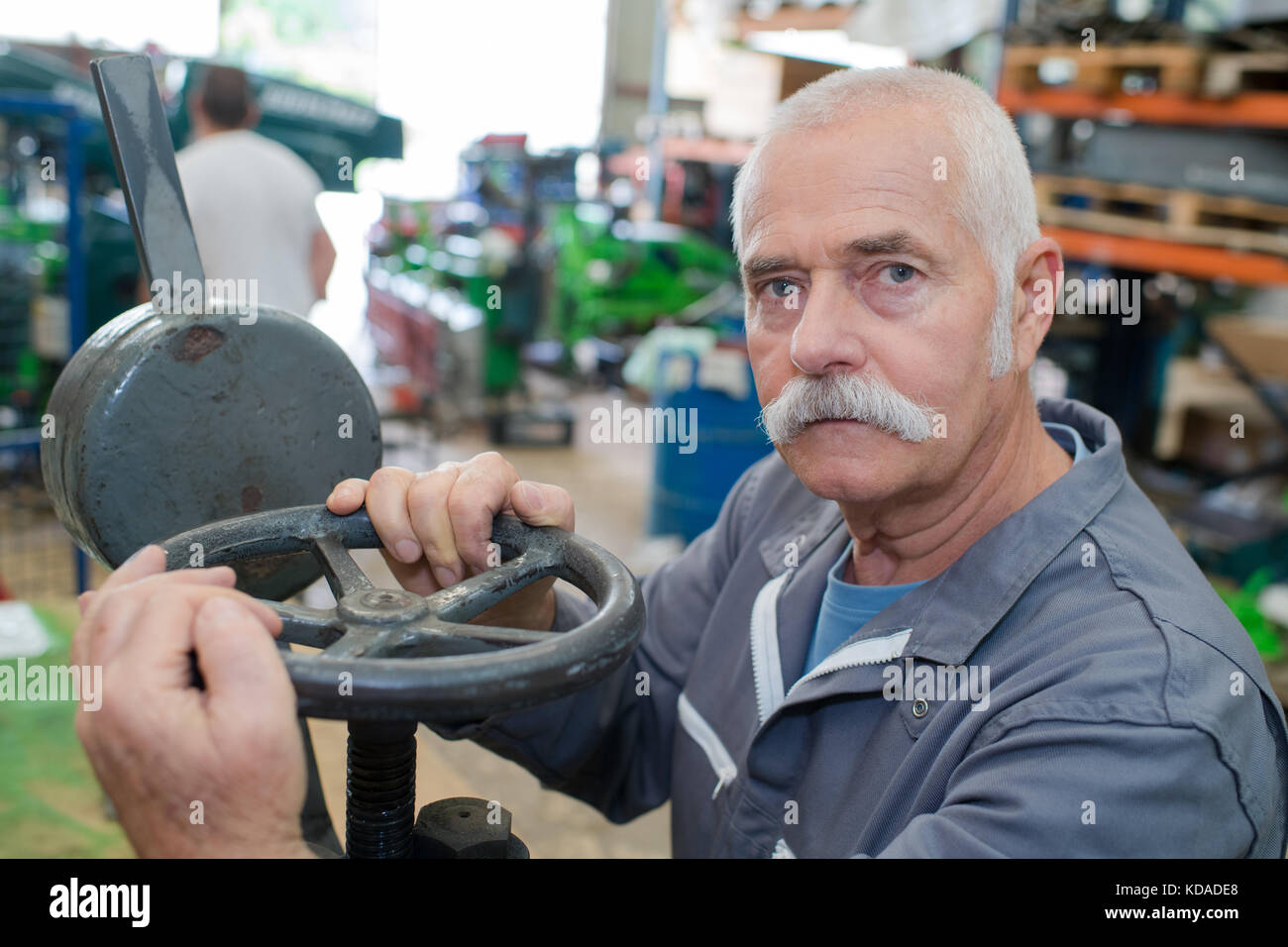 smiling worker looking at camera in warehouse Stock Photo - Alamy