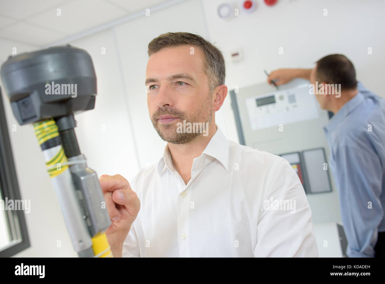 Man testing electrical equipment Stock Photo - Alamy