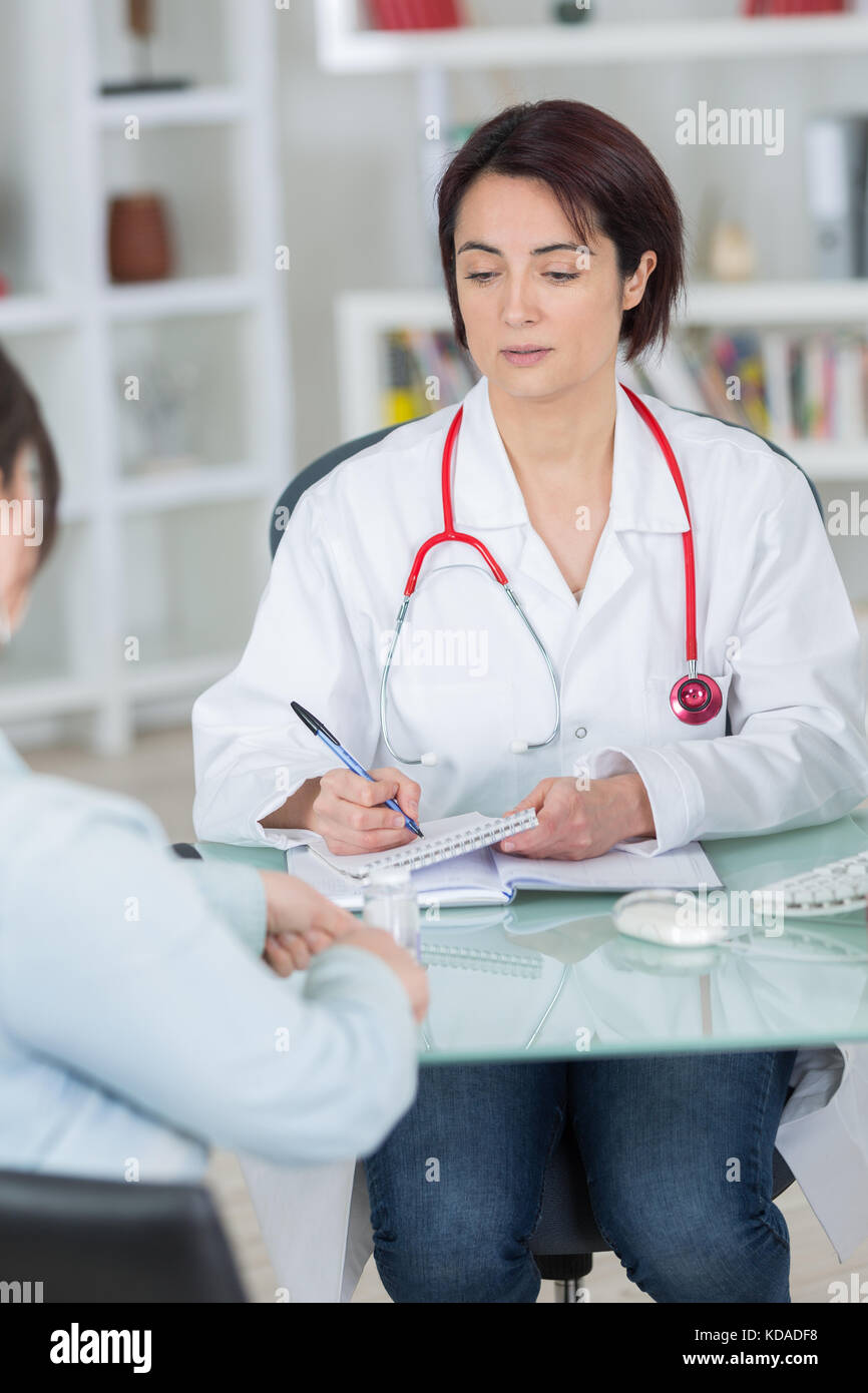 Writing prescription after diagnosing hi-res stock photography and ...