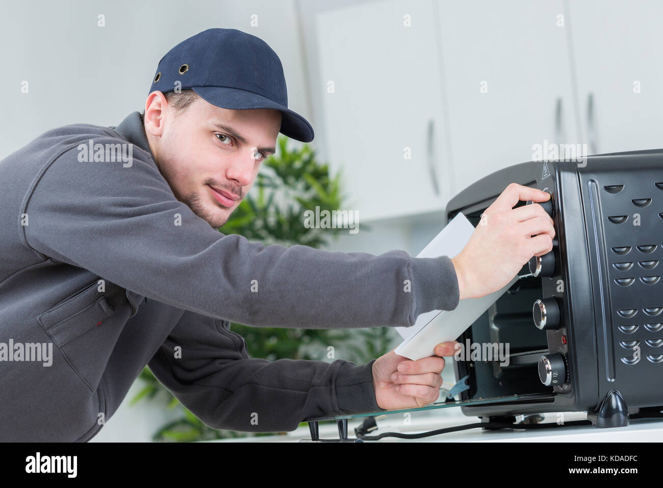 Man setting up appliance Stock Photo - Alamy