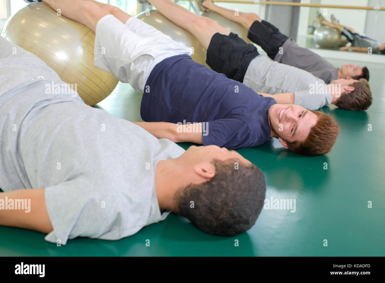 Four men legs raised hi-res stock photography and images - Alamy