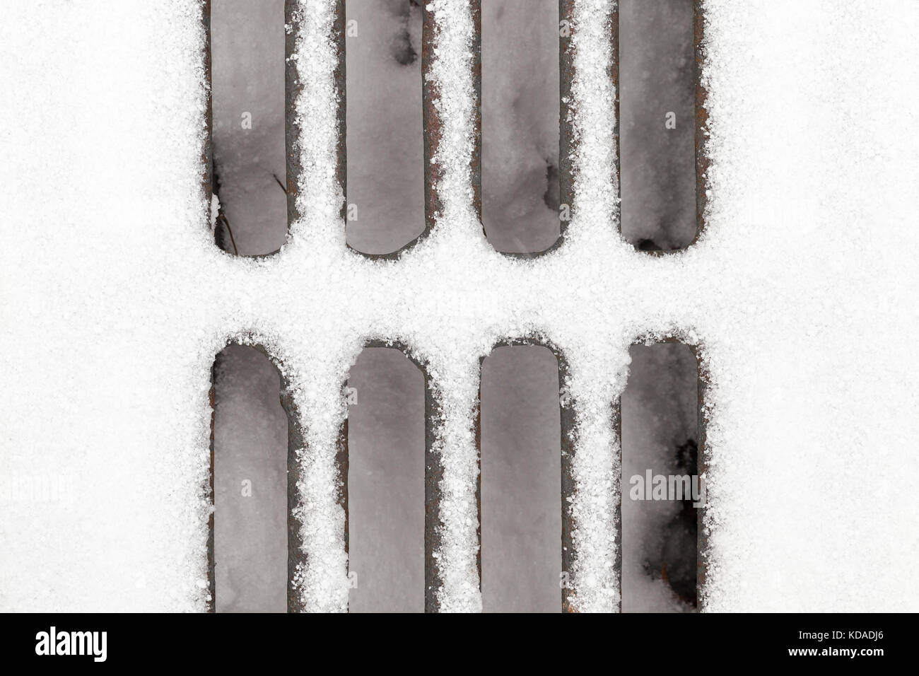 Grate under snow Stock Photo - Alamy