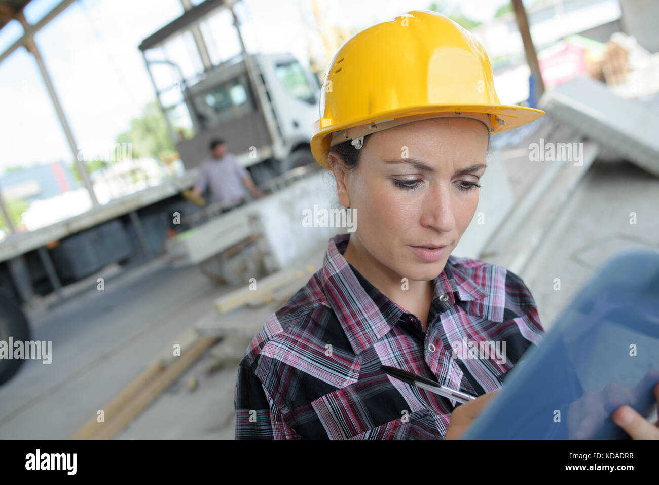 female builder writes results of inspection outdoors Stock Photo - Alamy