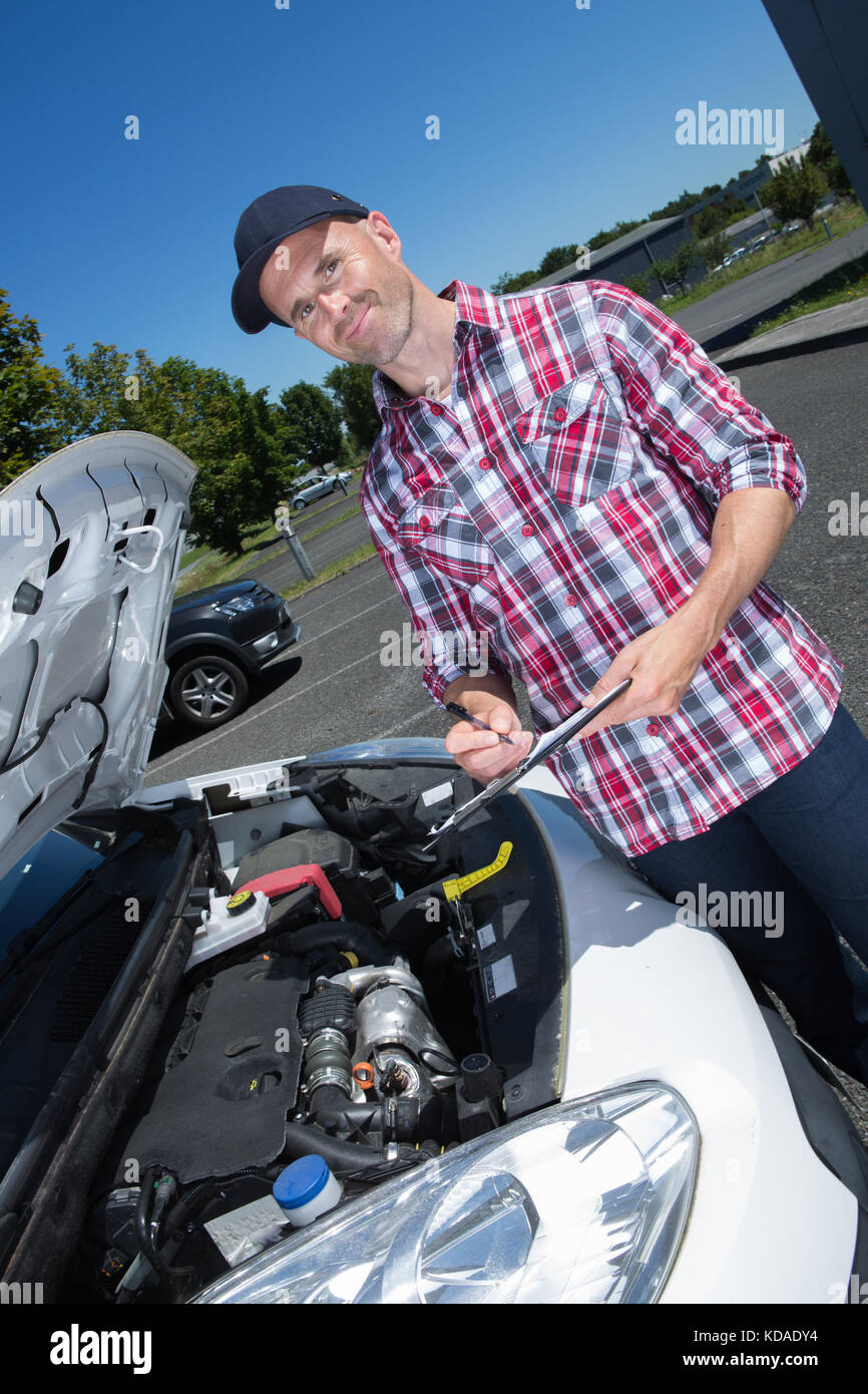handsome man checking car engine Stock Photo - Alamy