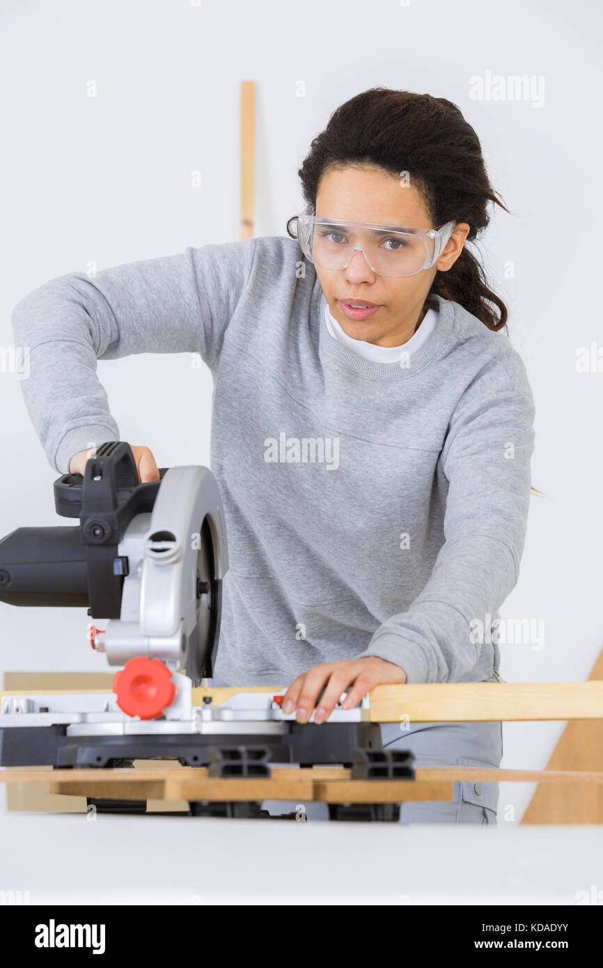 Female worker using circular saw Stock Photo - Alamy