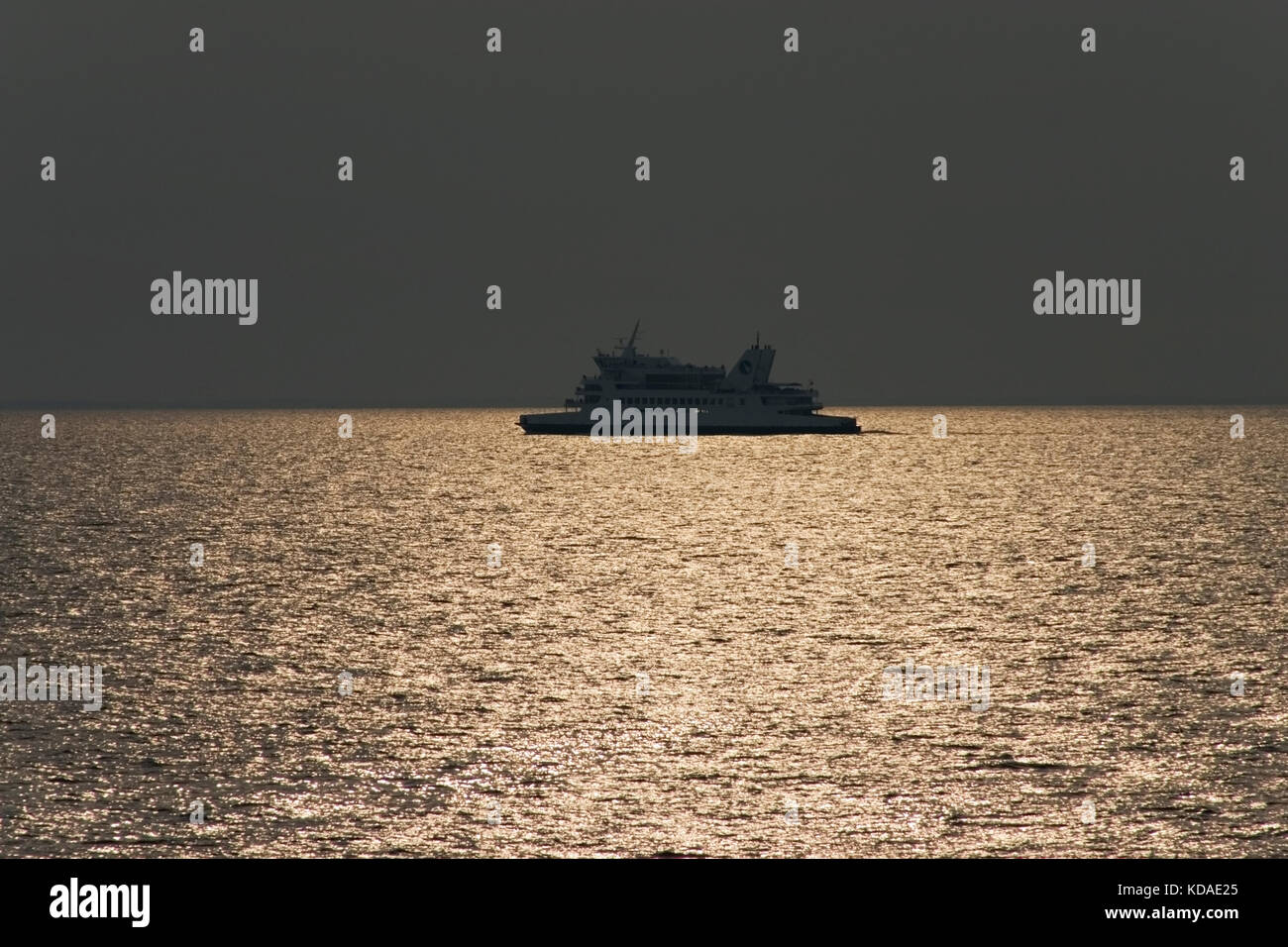 Ocean view with a ship in sunset light Stock Photo - Alamy