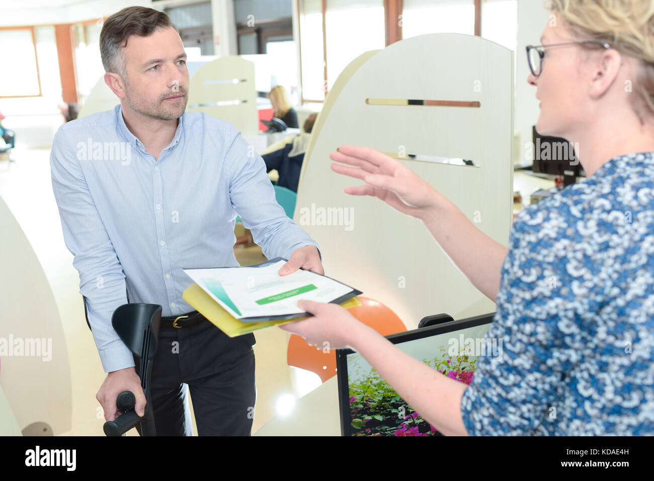 male patient meeting advisor at health insurance office Stock Photo - Alamy