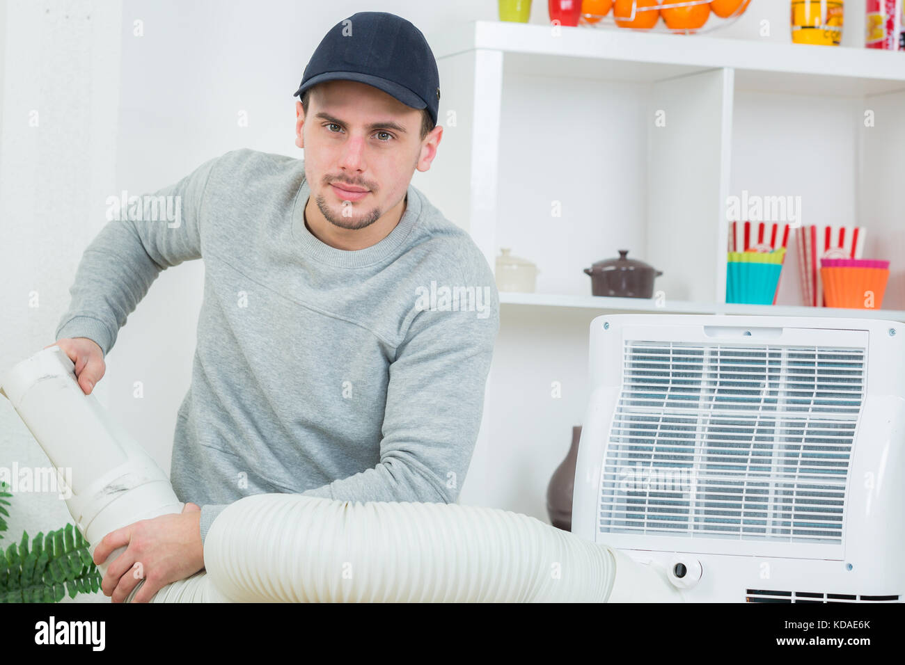 handsome technician installing air-conditioner in building Stock Photo ...