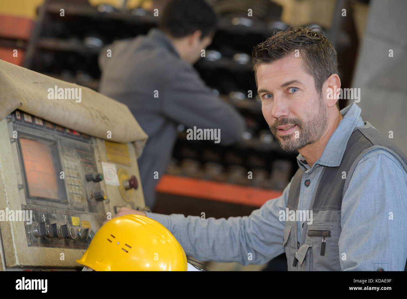 Portrait of man operating machine Stock Photo - Alamy