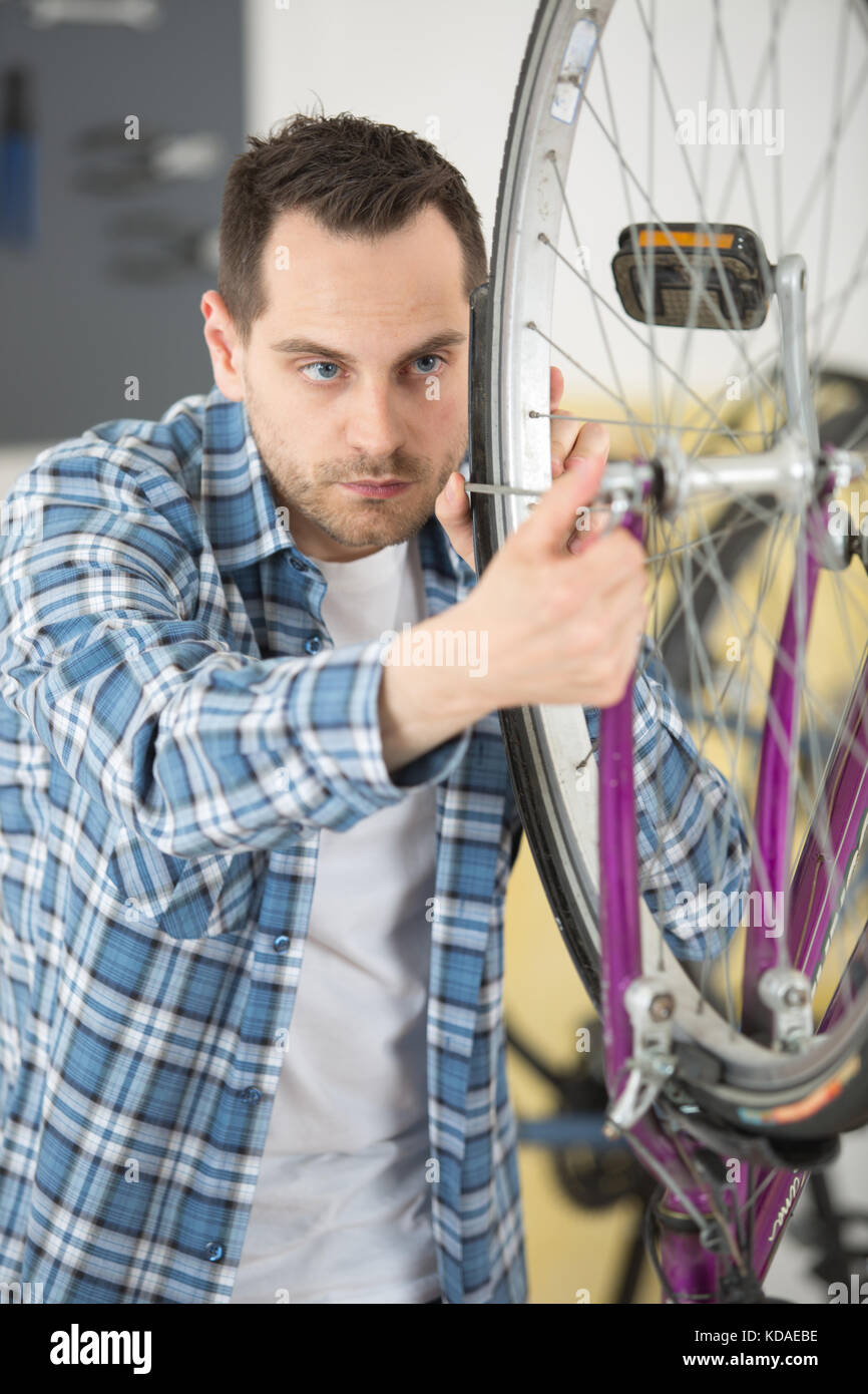 man pumping wheel bike Stock Photo - Alamy