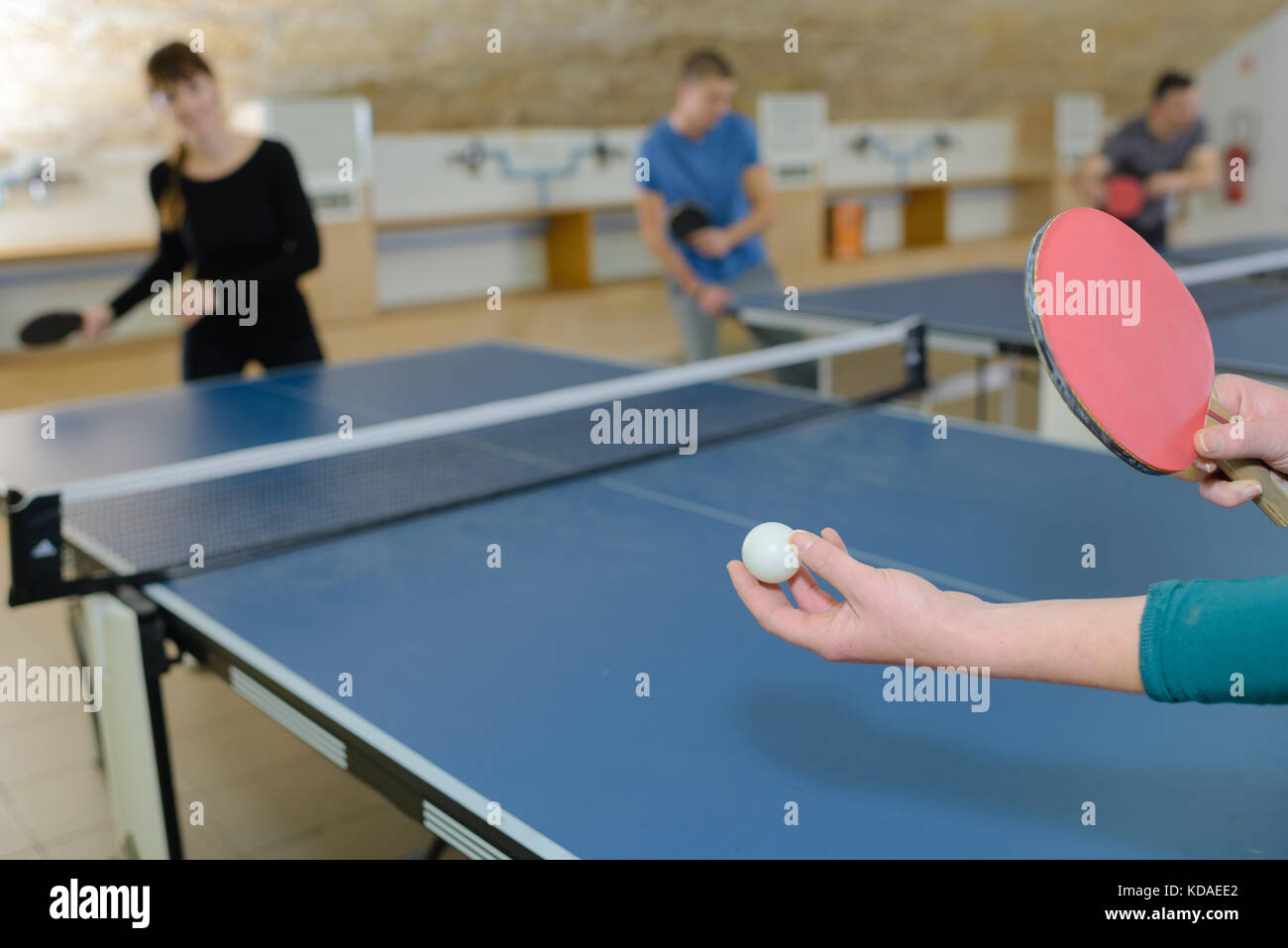 pretty woman playing ping-pong with friends Stock Photo - Alamy