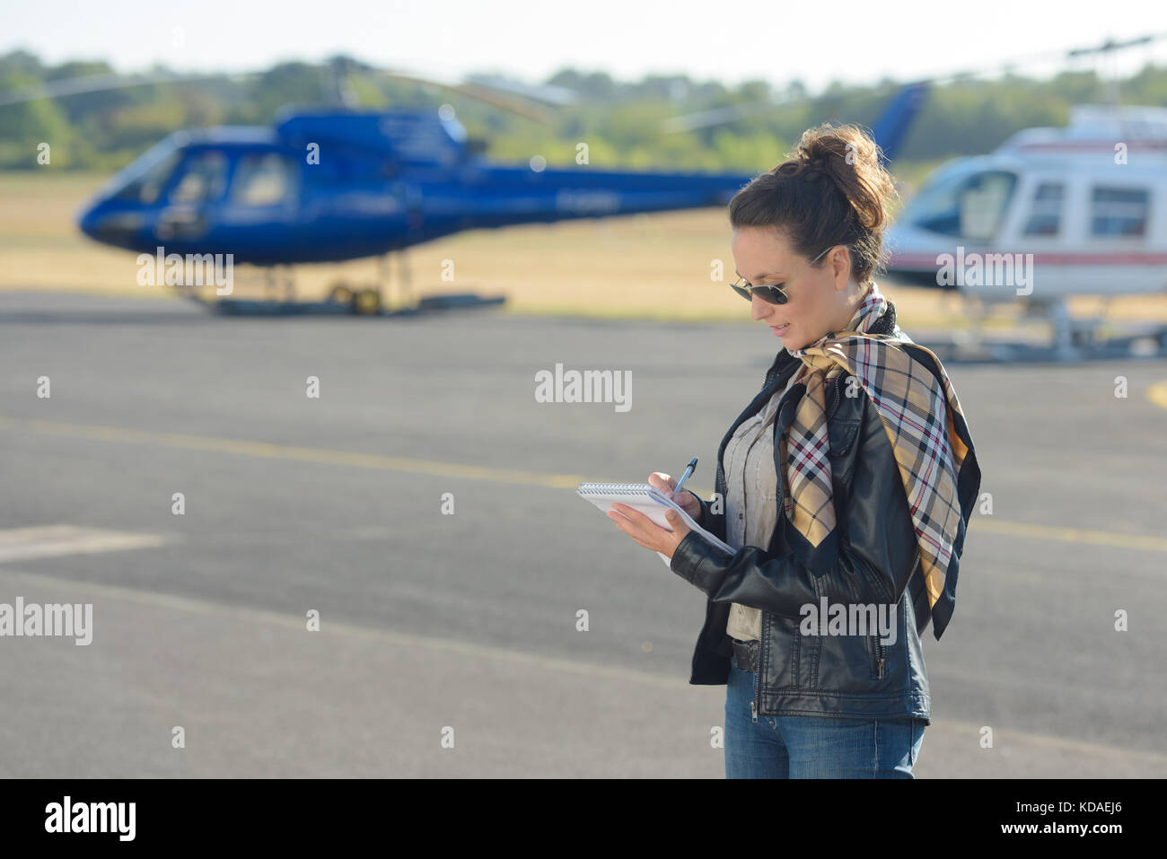 female pilot talking notes before flying Stock Photo - Alamy