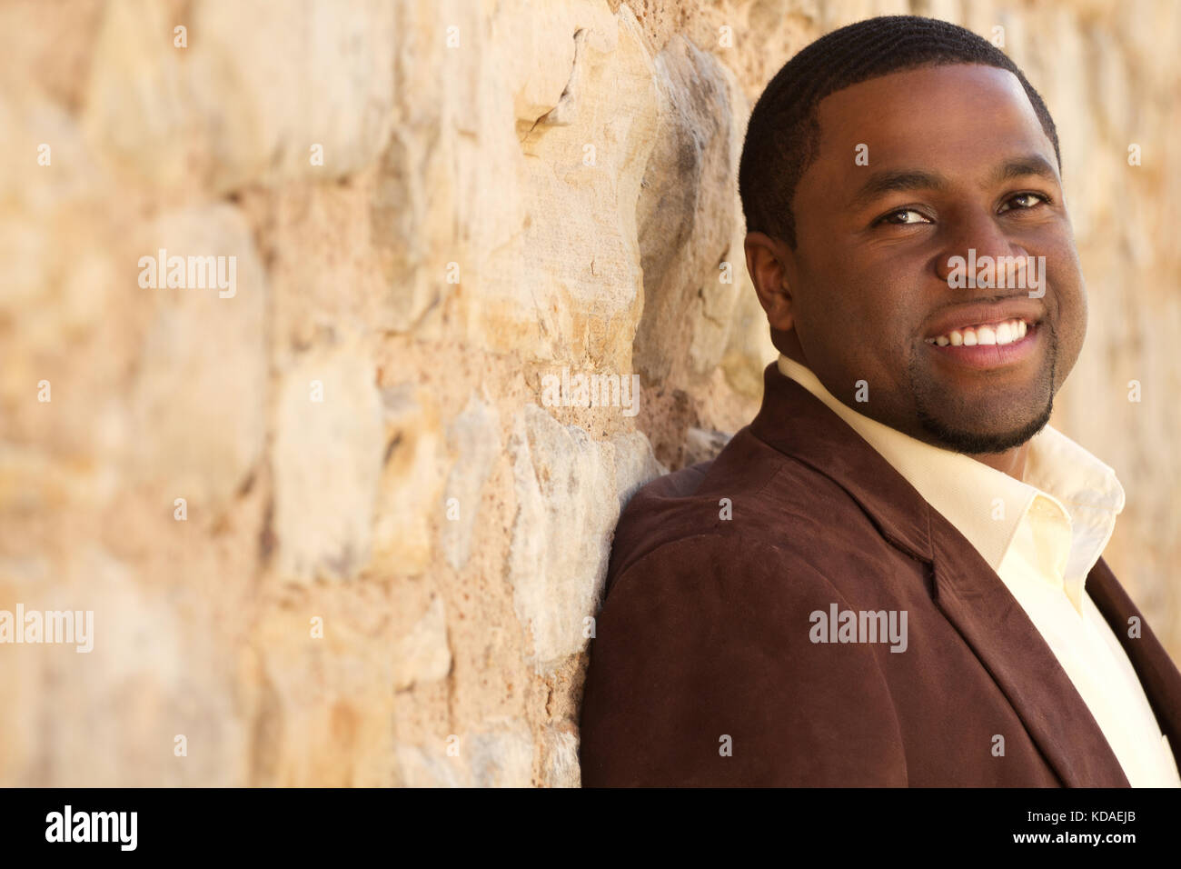 Young African American man smiling outside Stock Photo - Alamy