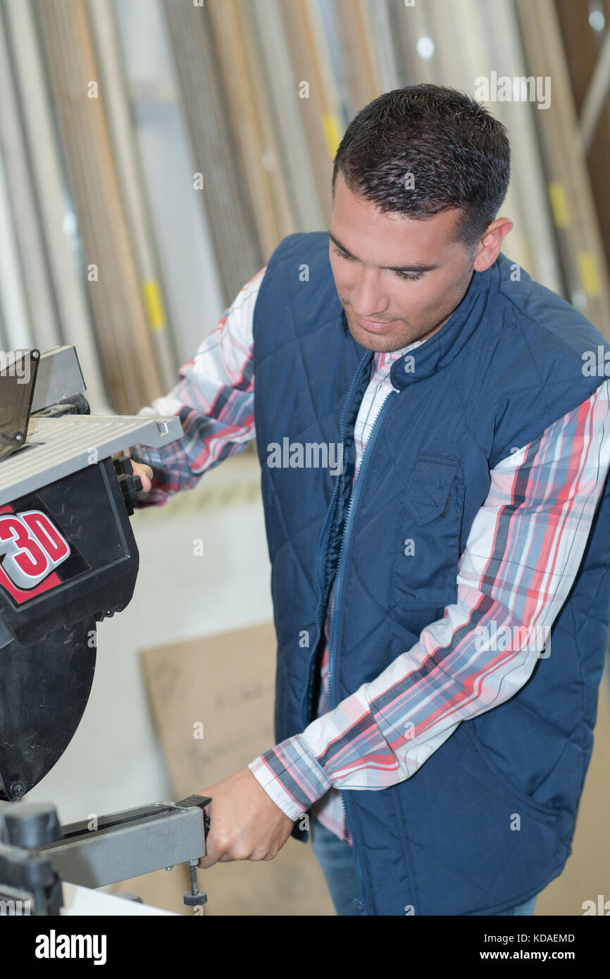 man cutting wood on a circular saw Stock Photo - Alamy