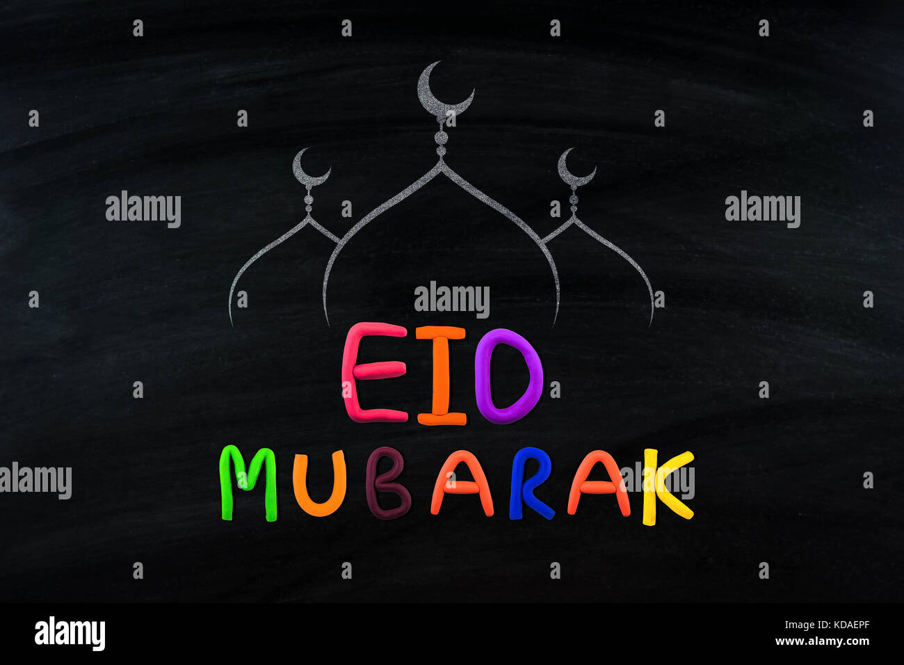 Eid Mubarak, traditional Muslim greeting . On blackbroad Stock Photo ...