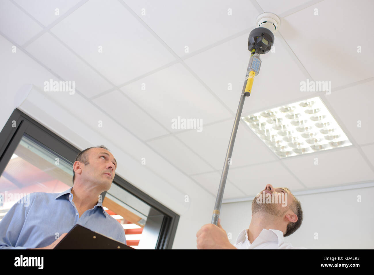 inspecting smoke alarms Stock Photo - Alamy