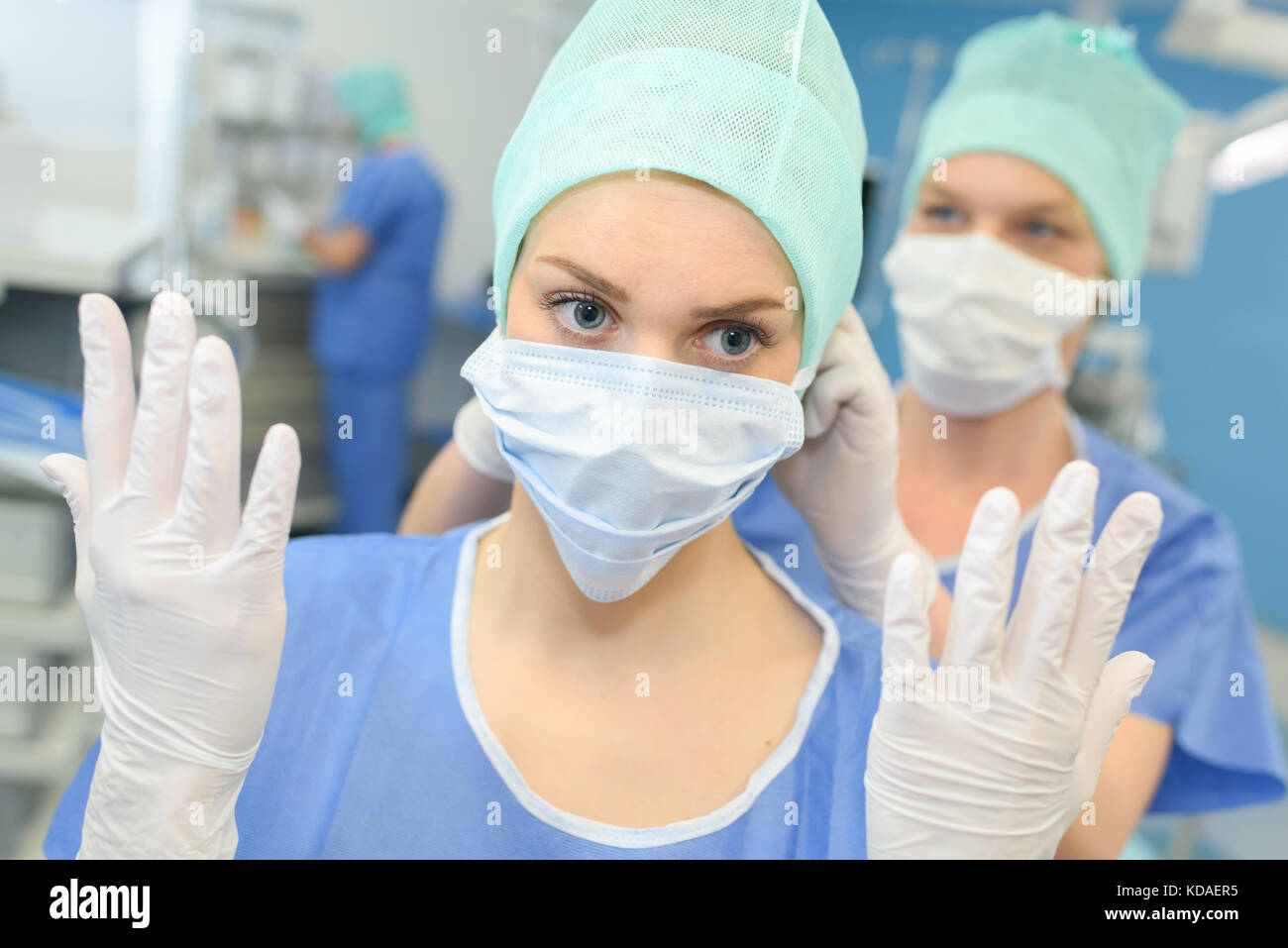 female surgeon in uniform getting ready for medical procedure surgery ...