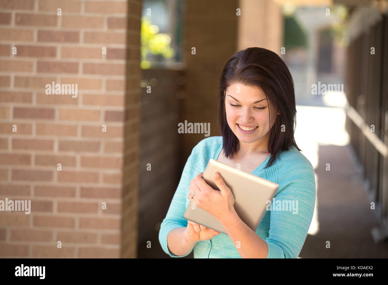 Woman smiling holding a notebook Stock Photo - Alamy