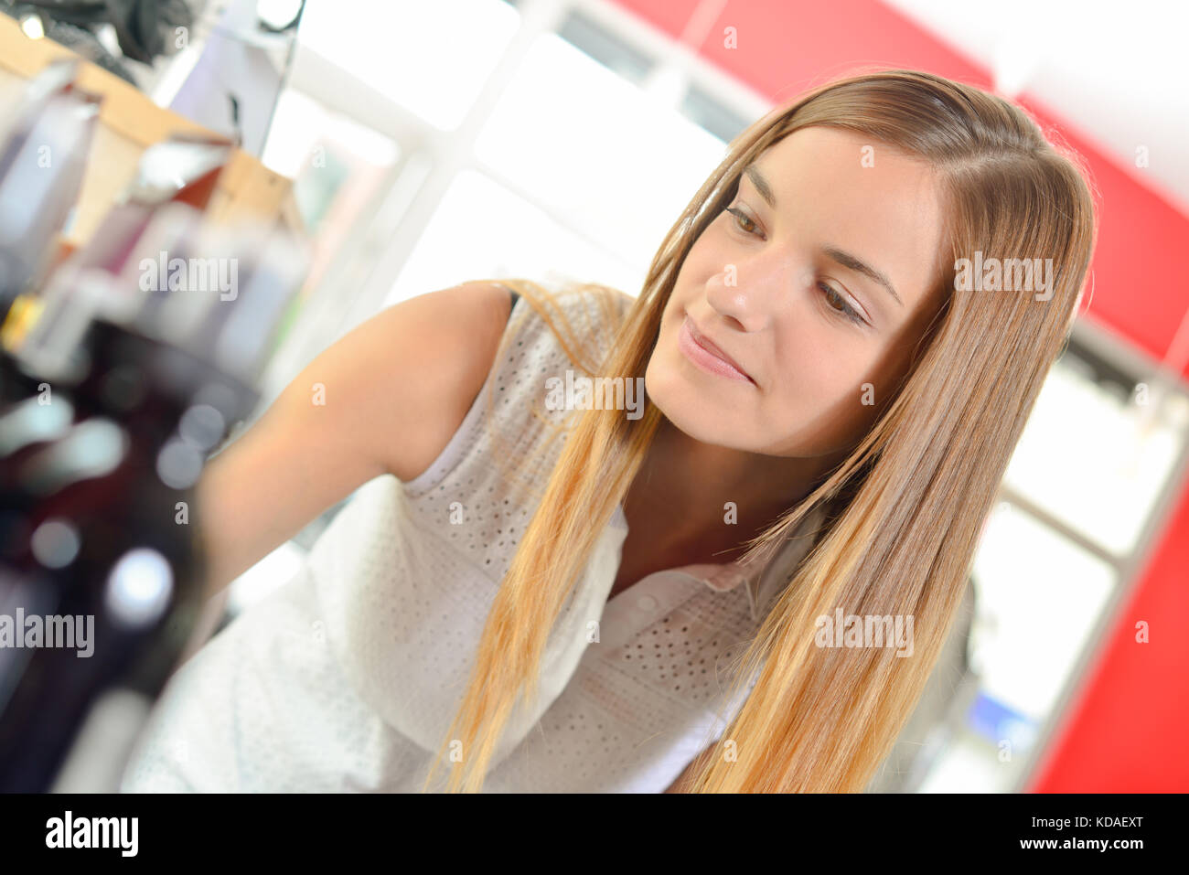 lady leaning over to look at products in a shop Stock Photo - Alamy