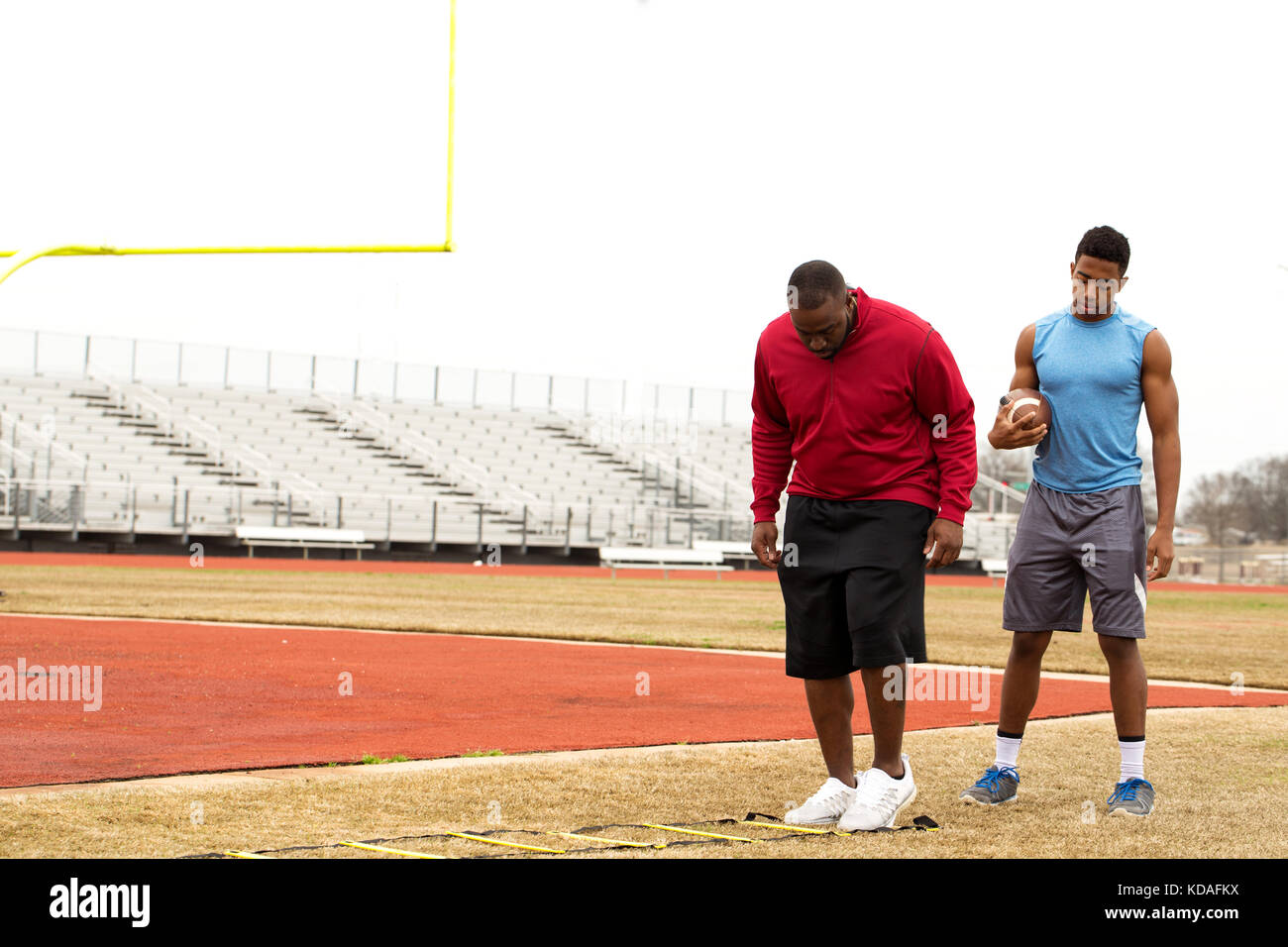 Coach training a high school athlete Stock Photo - Alamy
