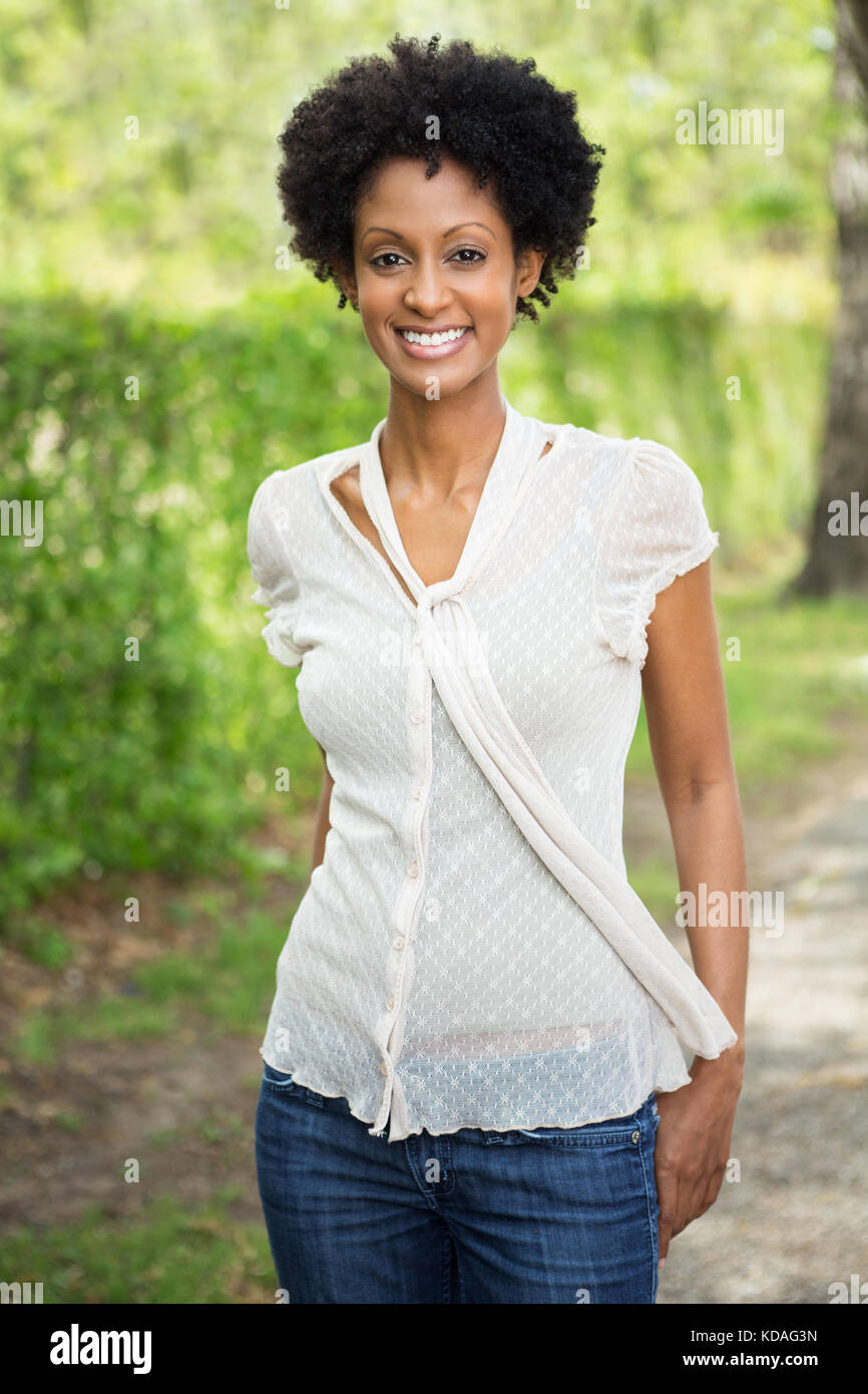 Beautiful woman smiling outside Stock Photo - Alamy