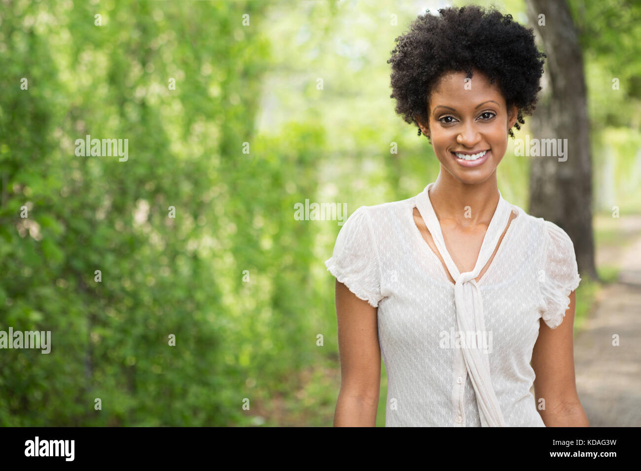 Beautiful woman smiling outside Stock Photo - Alamy