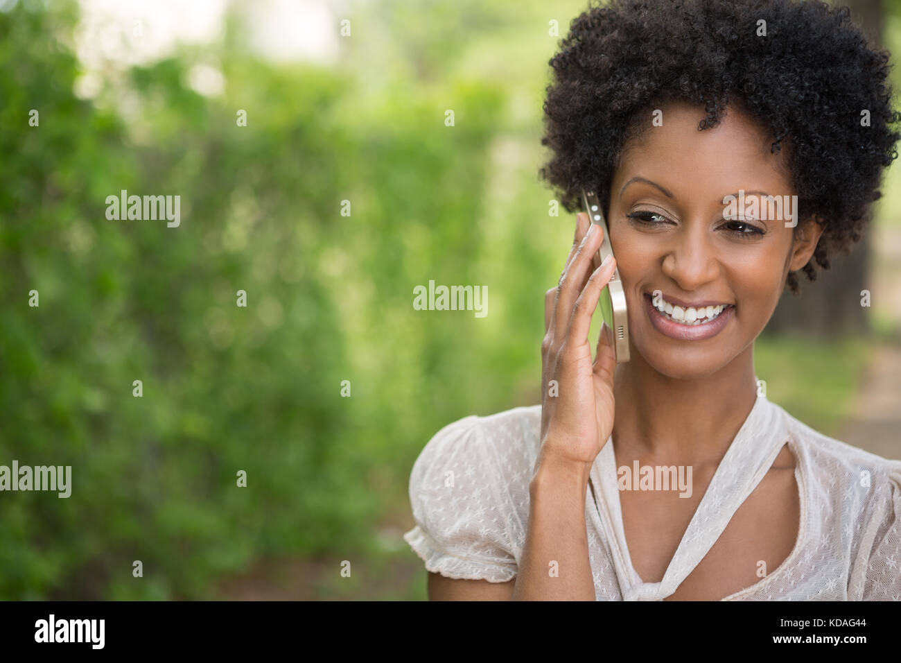 Beautiful woman smiling outside Stock Photo - Alamy