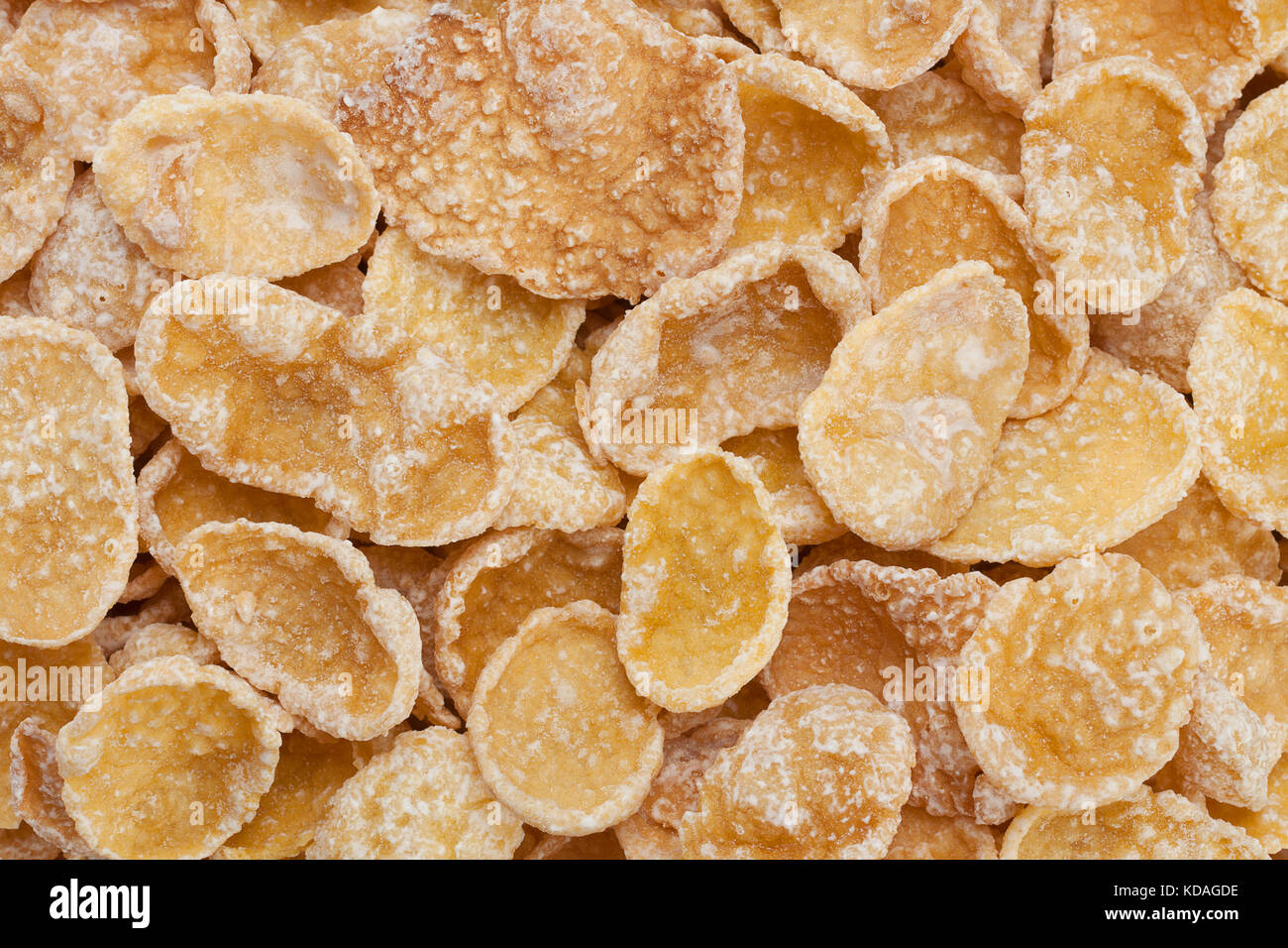Sweet corn flakes in sugar glazed closeup background Stock Photo - Alamy