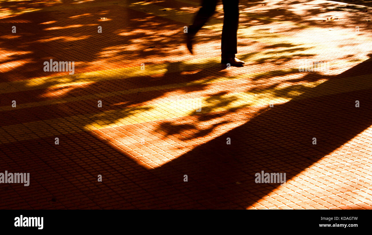 Blurry shadows and silhouettes of a person walking in motion blur and ...