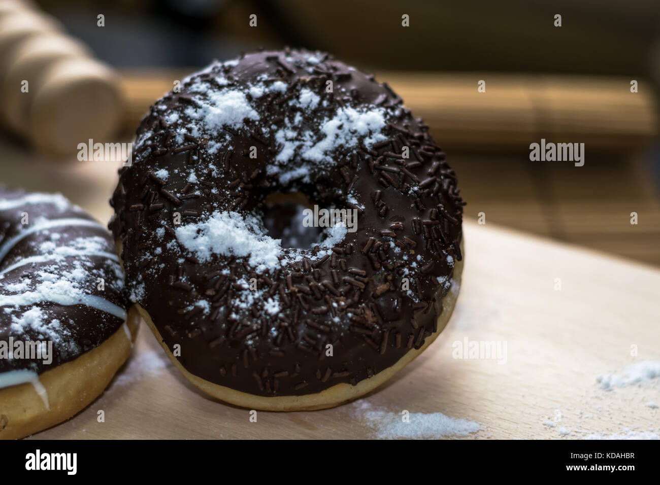 Chocolate glazed donuts close up side view Stock Photo - Alamy