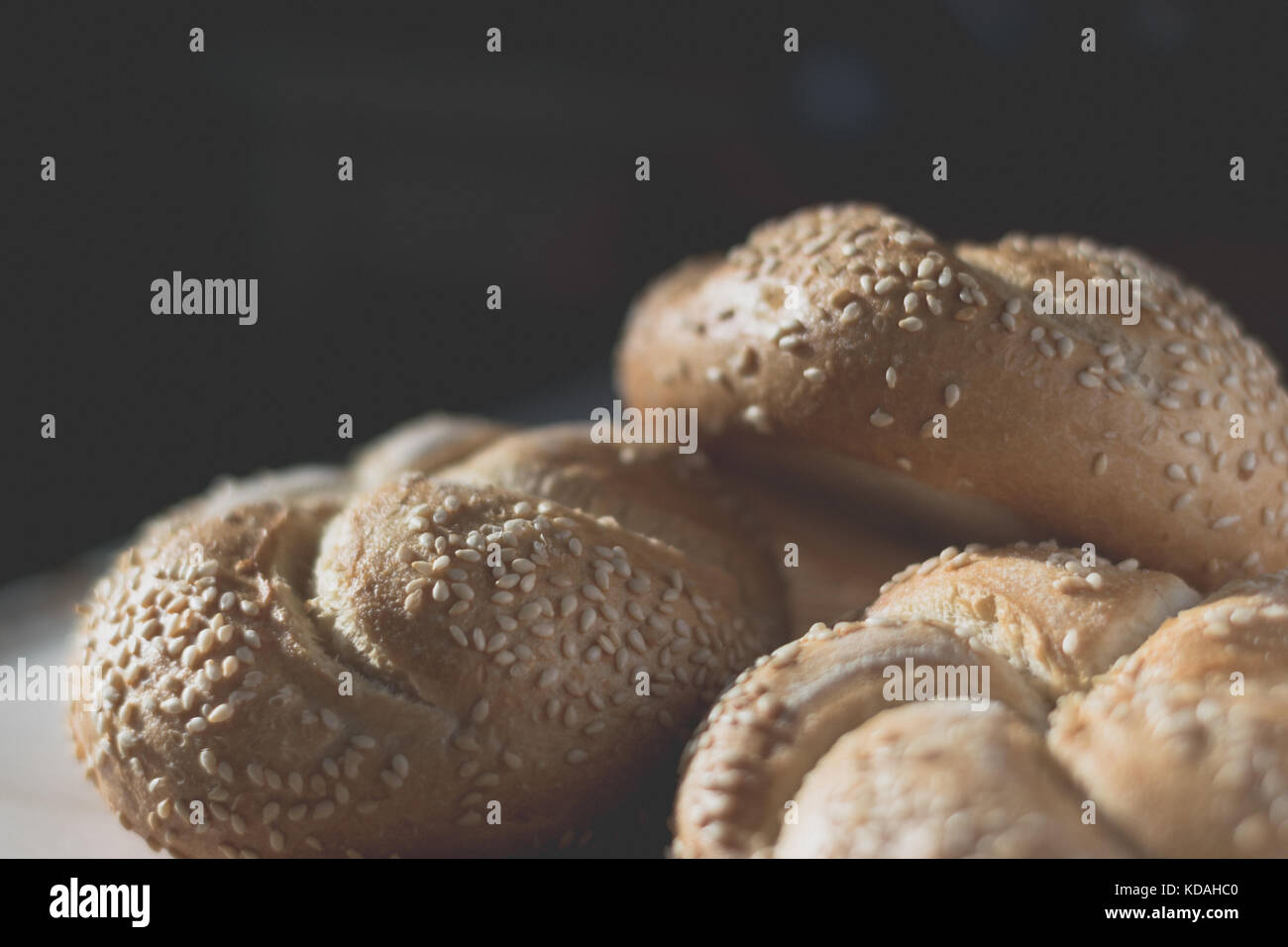 Bread buns with sesame seeds side view, dark background Stock Photo - Alamy