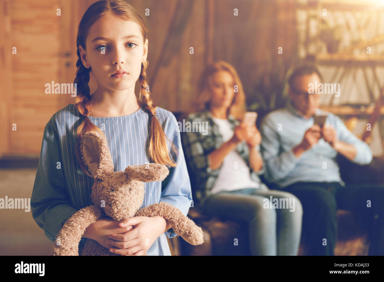 Ignored upset child posing with her bunny toy Stock Photo - Alamy