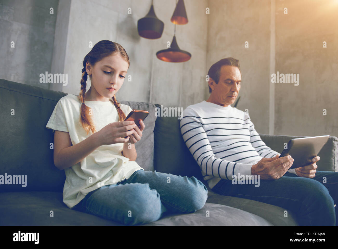 Not very close father and daughter ignoring each other Stock Photo - Alamy