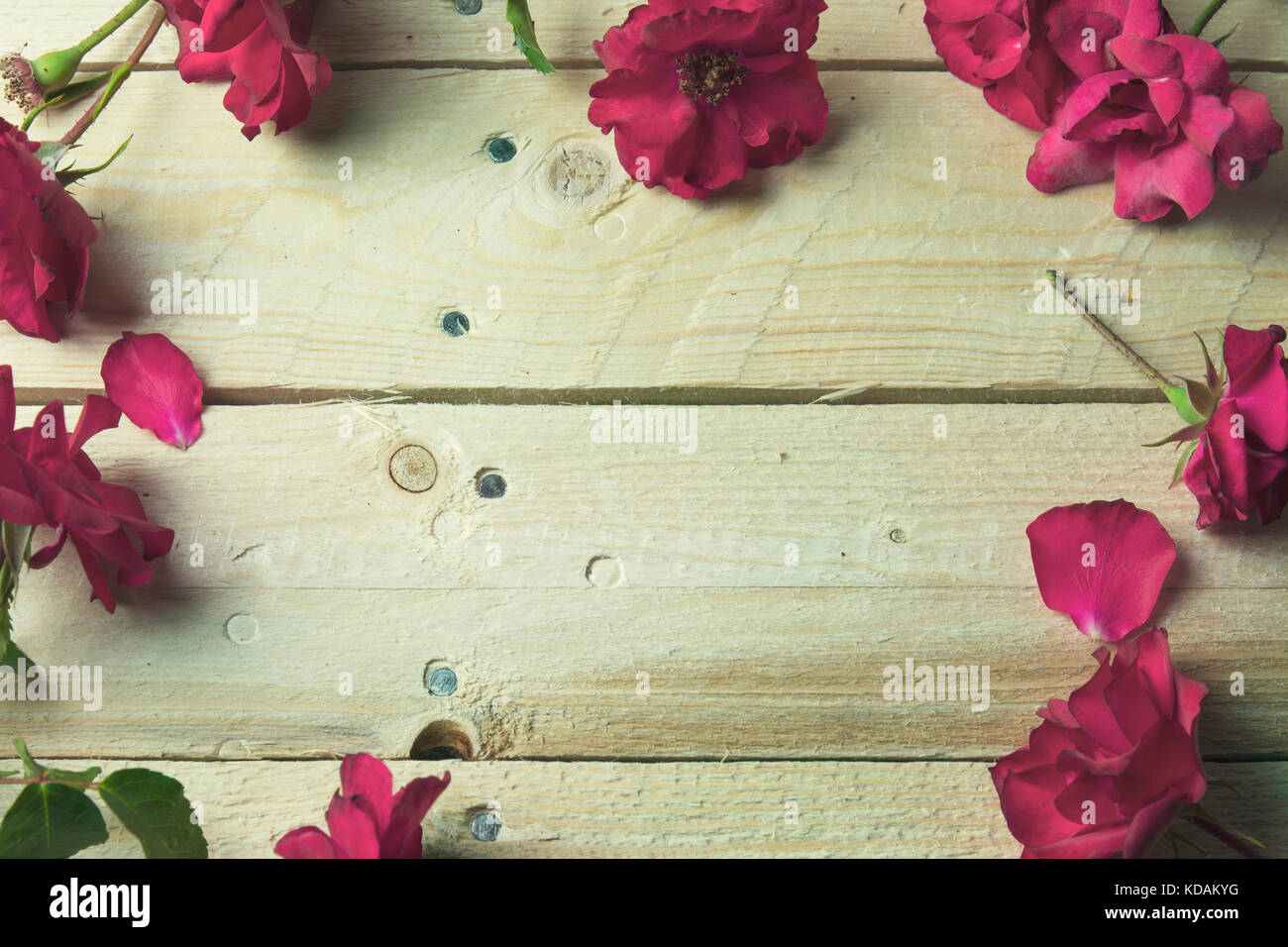 Frame of red roses on wooden background Stock Photo - Alamy