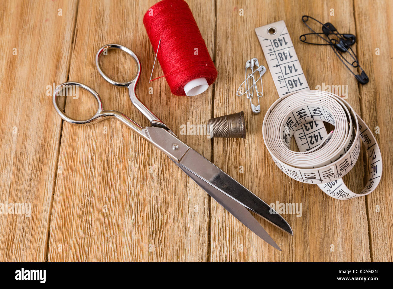 Sewing tools and sewing kit on a wooden background Stock Photo - Alamy