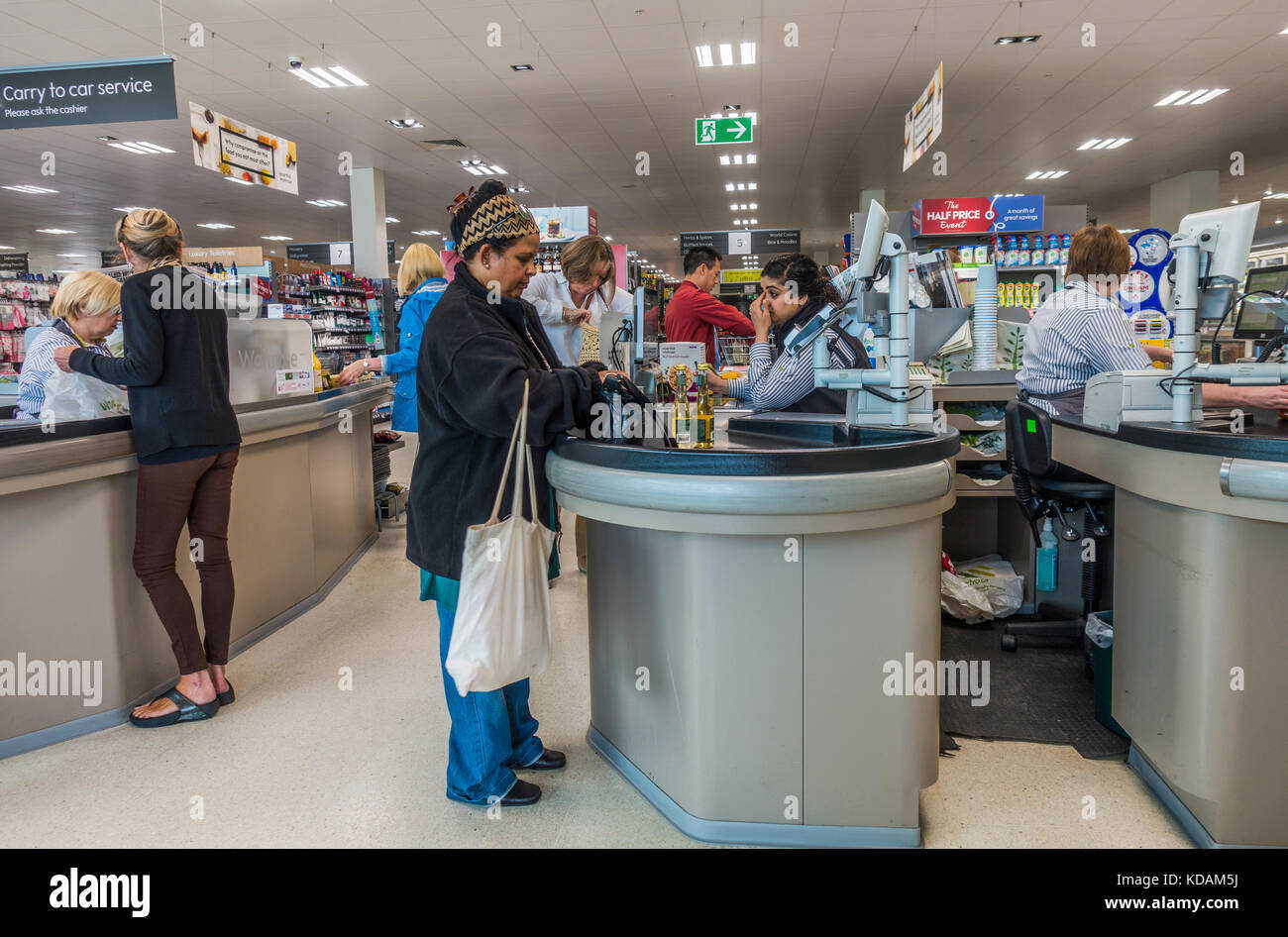 Customers standing at checkouts at the Peterborough branch of Waitrose ...