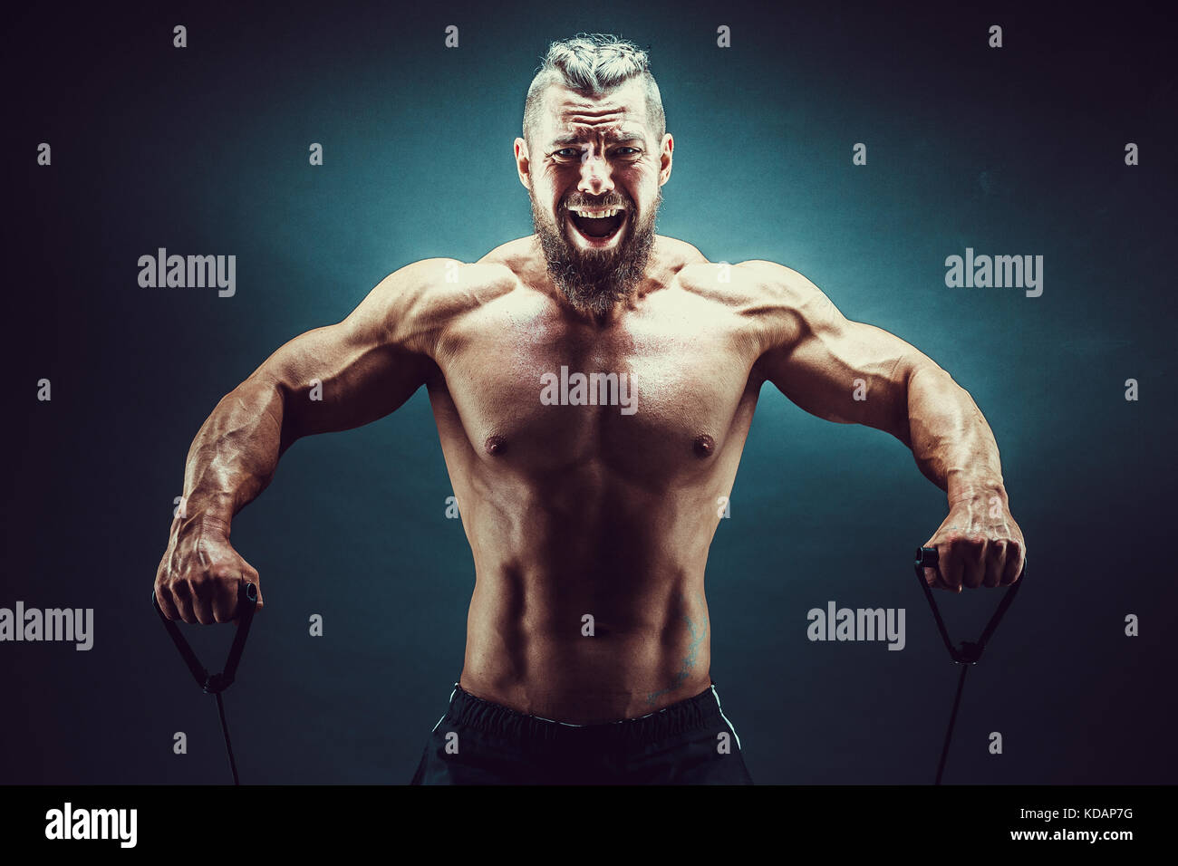 Fitness man exercising with stretching band. Muscular sports man ...