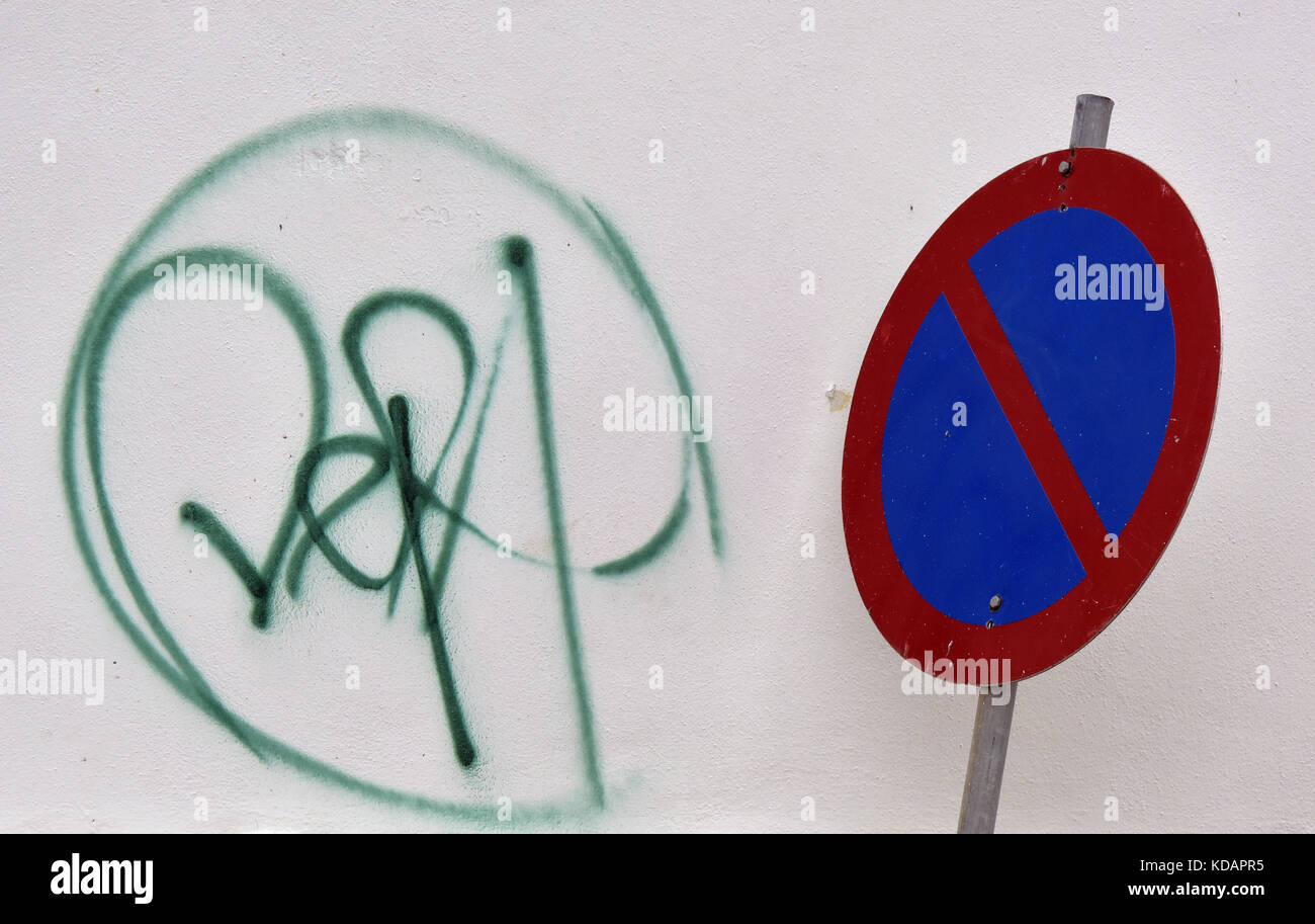 A bent or damaged traffic sign for an urban clearway in blue and red ...