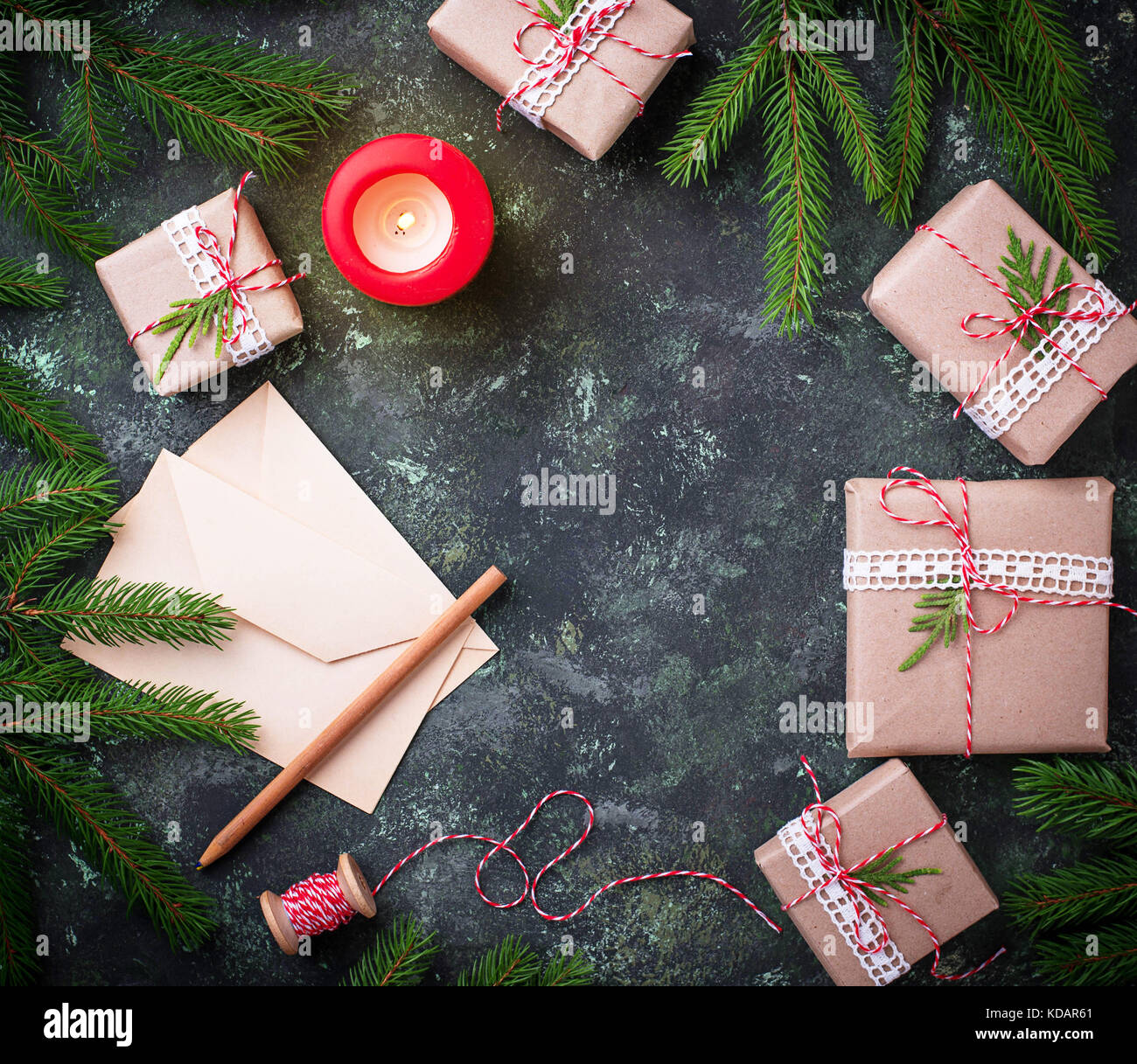 Christmas background. Gift boxes, letter and candle Stock Photo - Alamy