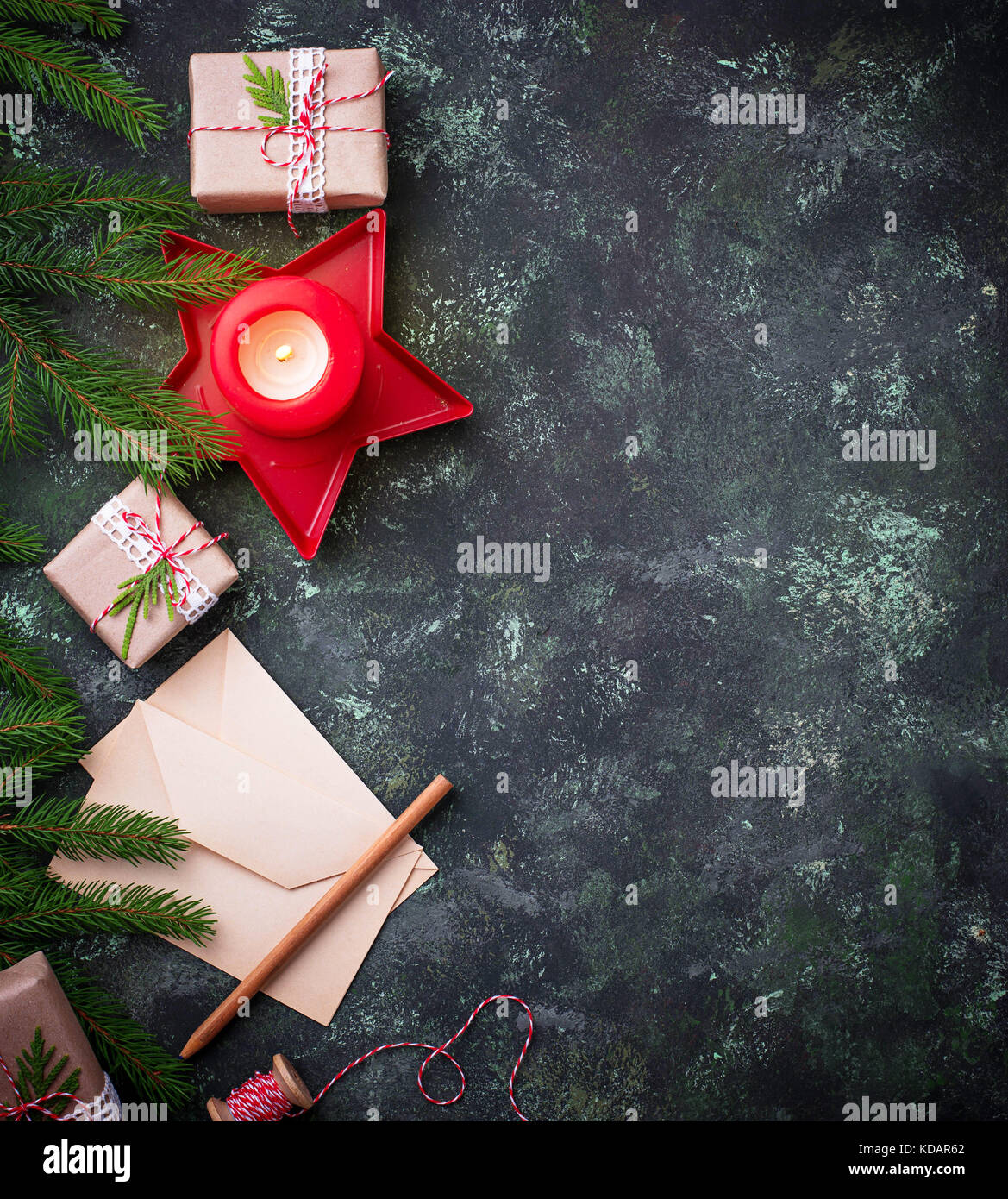 Christmas background. Gift boxes, letter and candle Stock Photo - Alamy