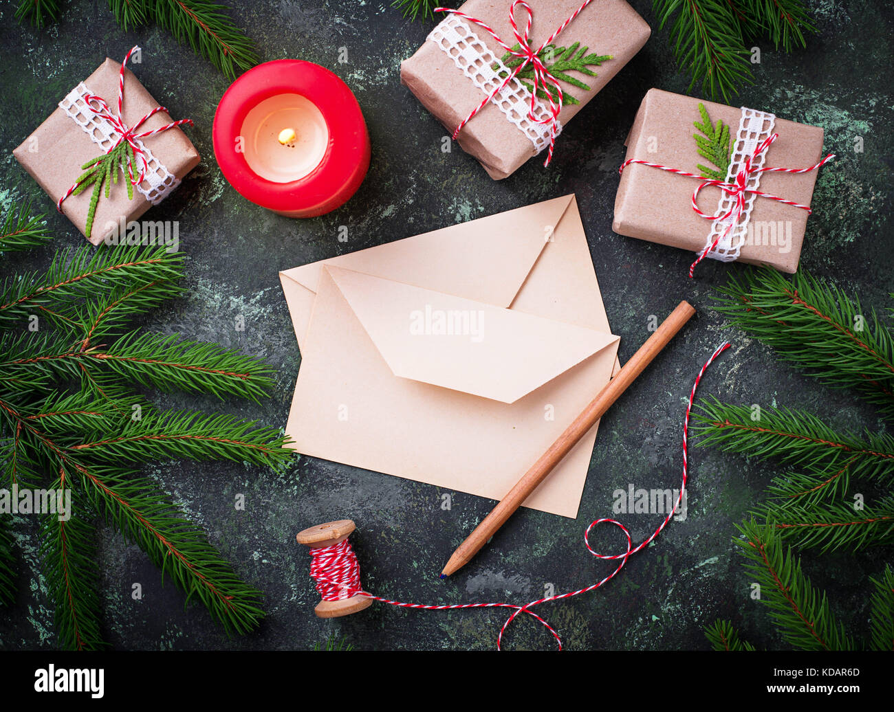 Christmas background. Gift boxes, letter and candle Stock Photo - Alamy