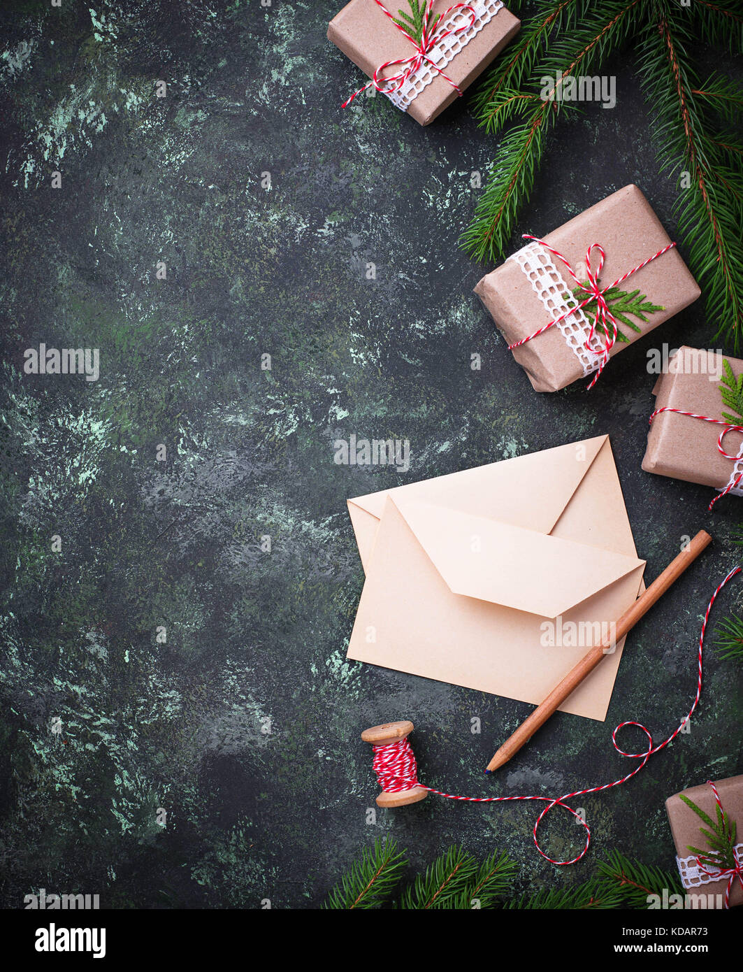 Christmas background. Gift boxes, letter and candle Stock Photo - Alamy