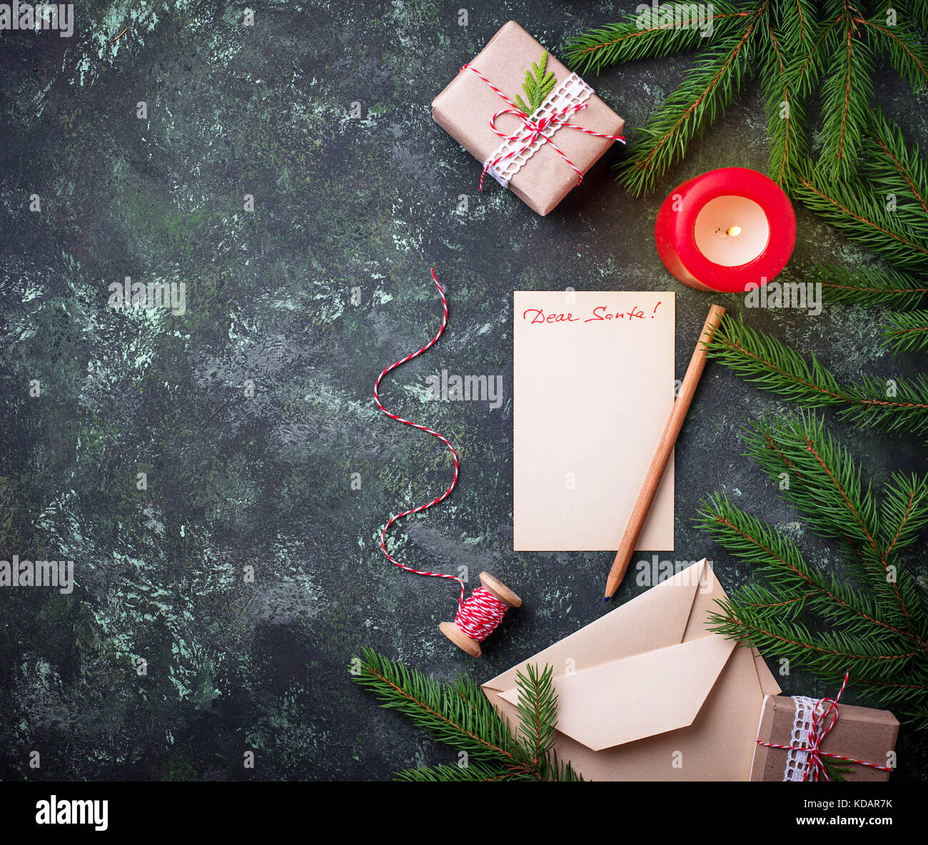 Christmas background. Gift boxes, letter and candle Stock Photo - Alamy