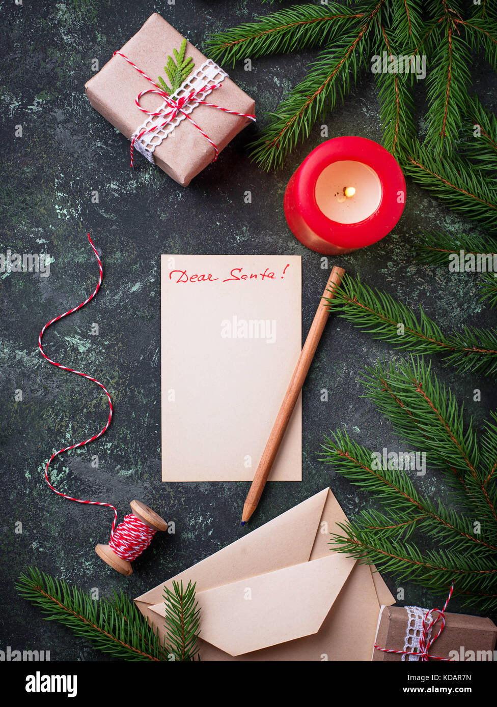 Christmas background. Gift boxes, letter and candle Stock Photo - Alamy