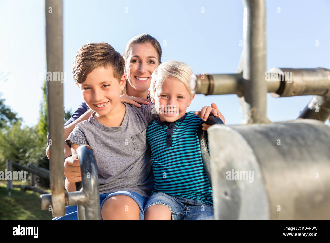 Two brothers playing together at toy excavator on playground Stock ...