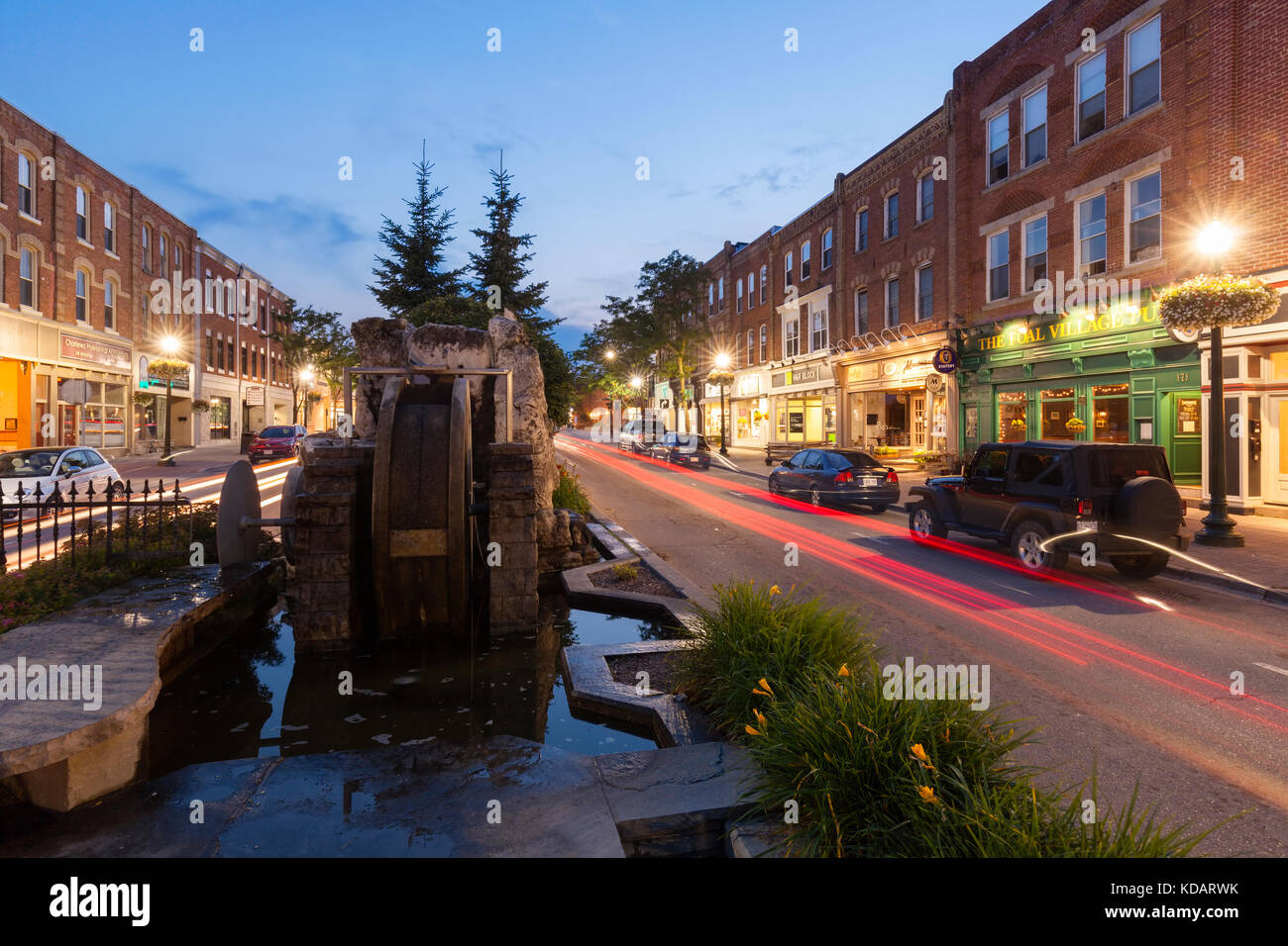 A water wheel and historical buildings in downtown along Broadway at ...