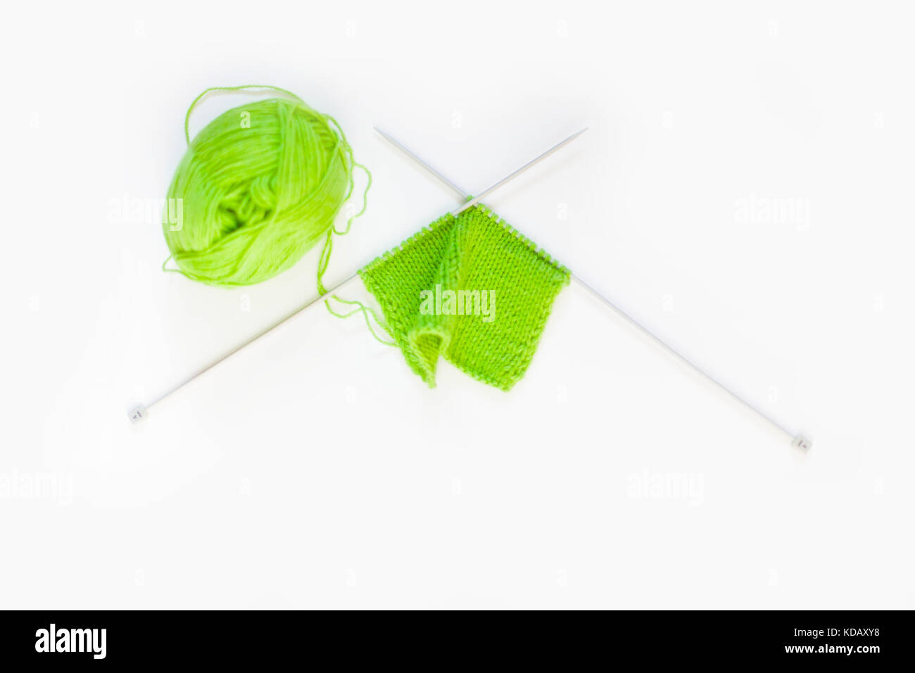 Knitted green. Yarn for knitting green. White background Stock Photo ...