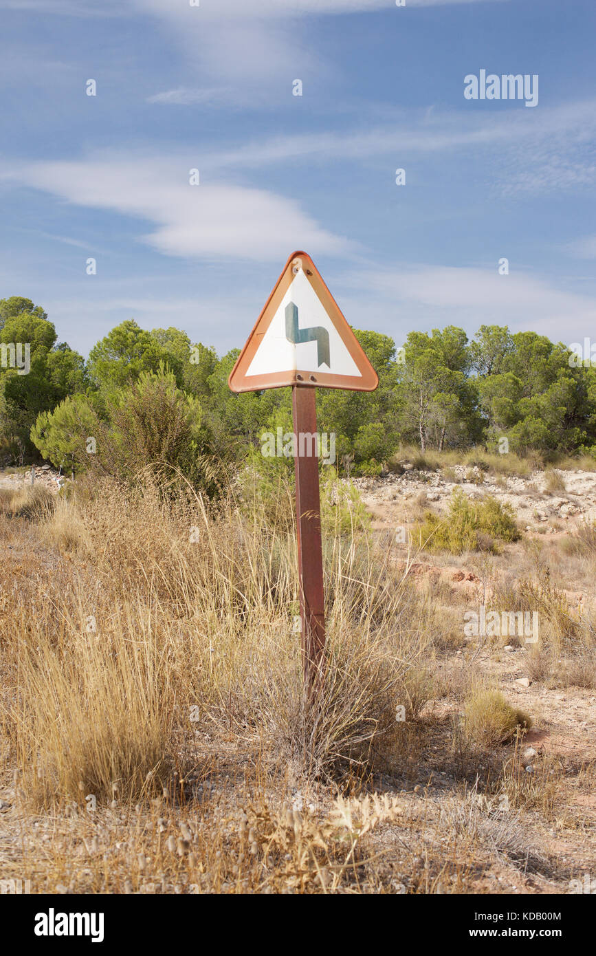 Roadside sign warning of bends Stock Photo - Alamy