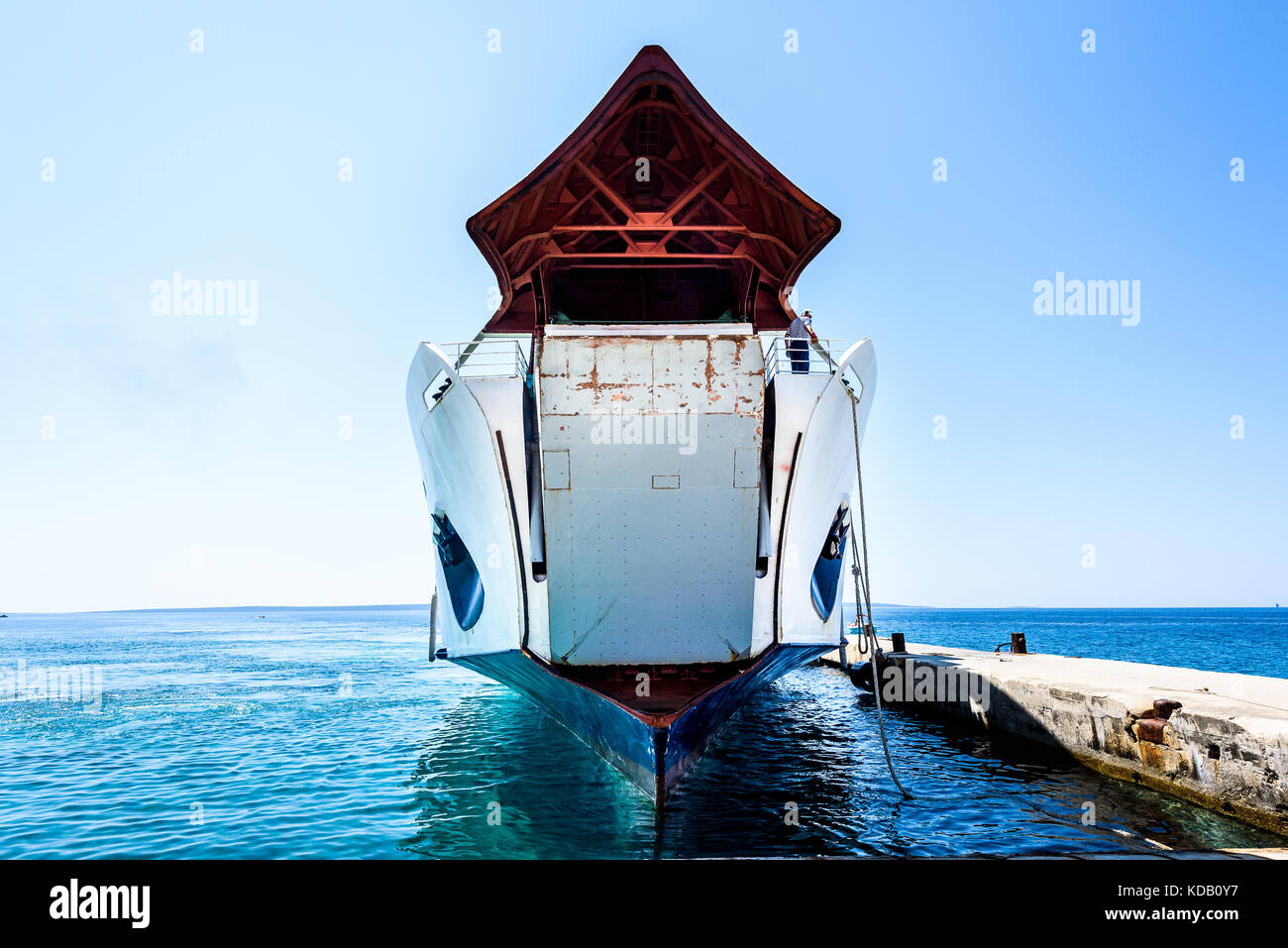 Front loading ferry boat moored with lifted bow at pier. Big ferry boat ...