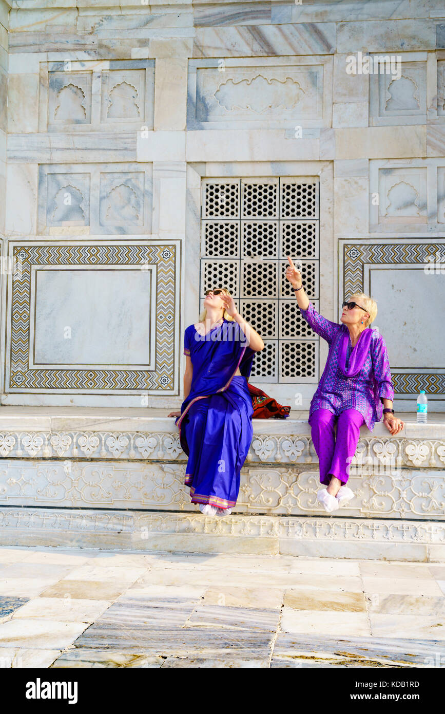 Two western woman dressed in Indian clothing at the Taj Mahal in Agra ...